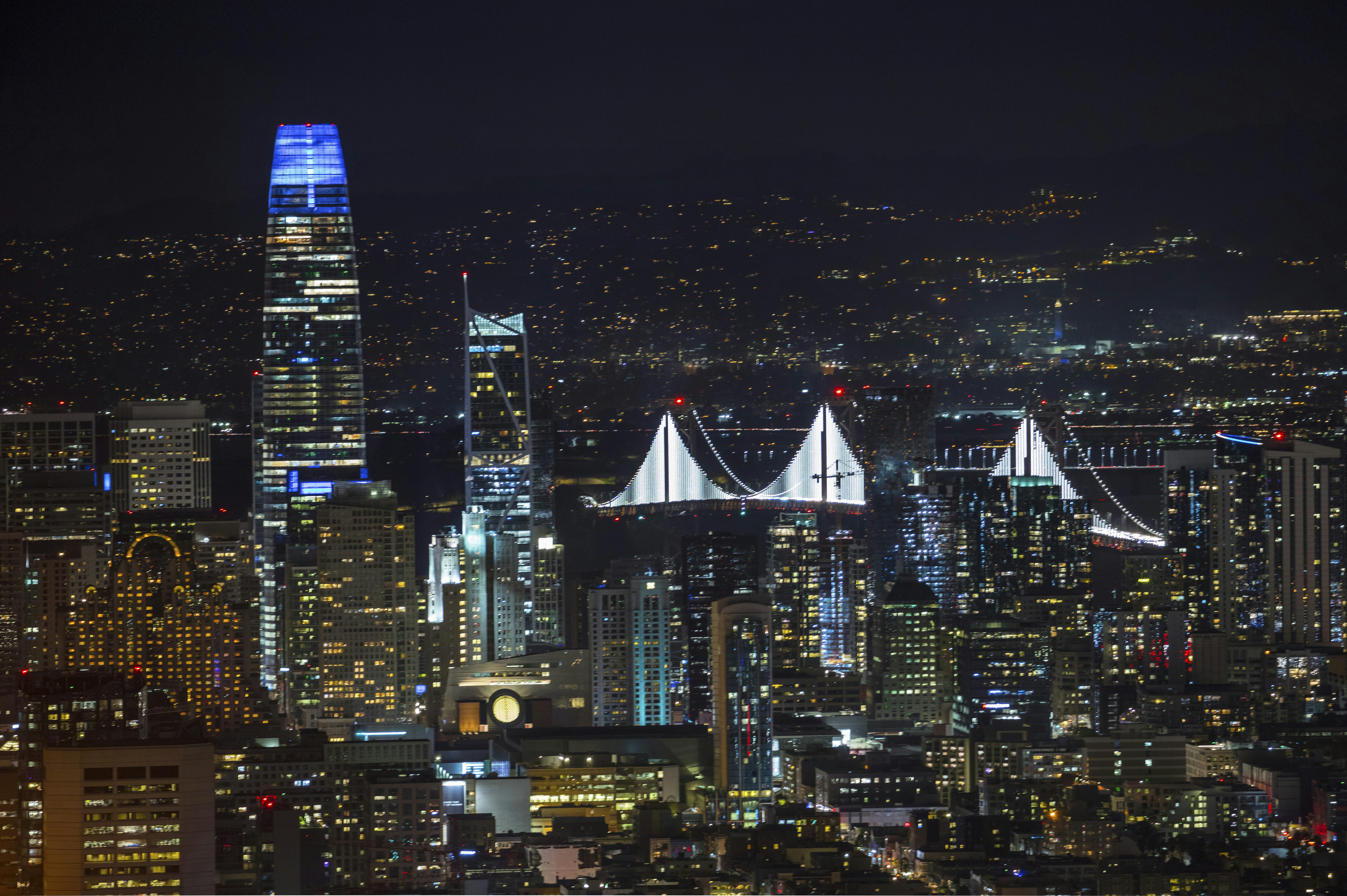 Midnight Skyline: Towering Glass and Sail-Topped Bridges