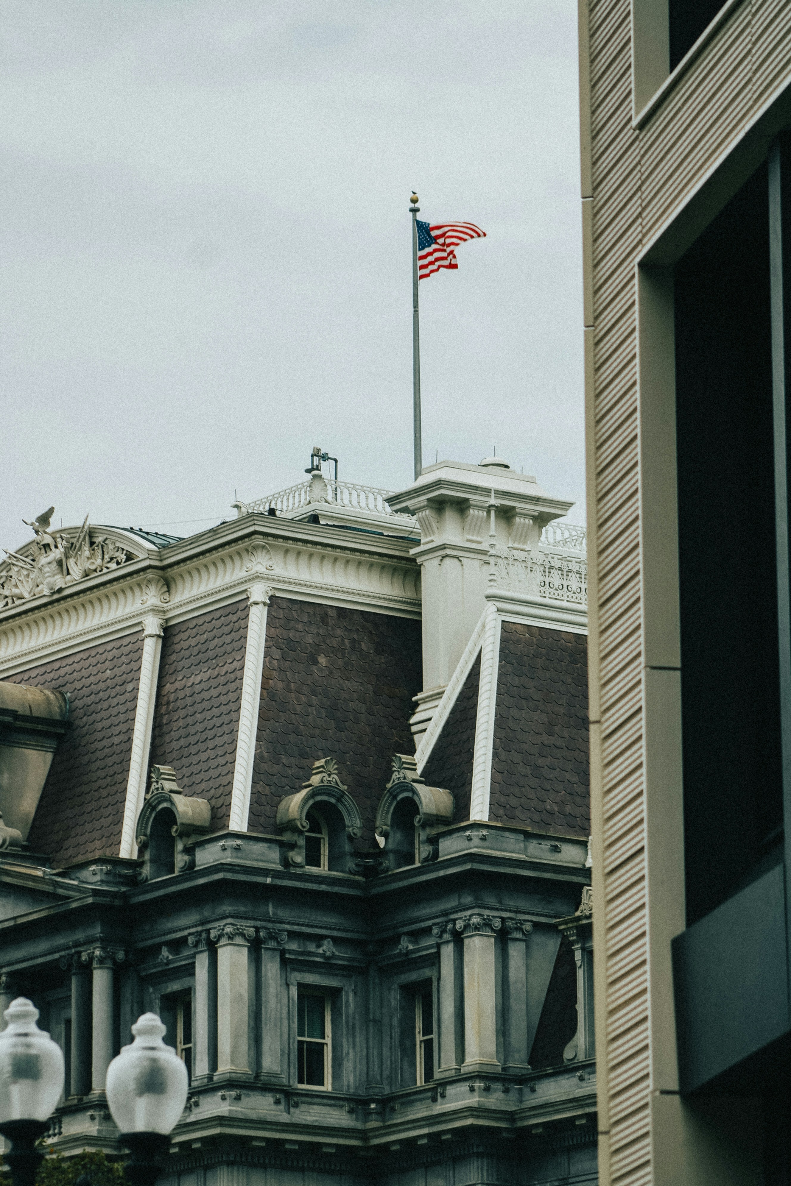 American Flag Above Historic Rooftop: A Cityscape Snapshot