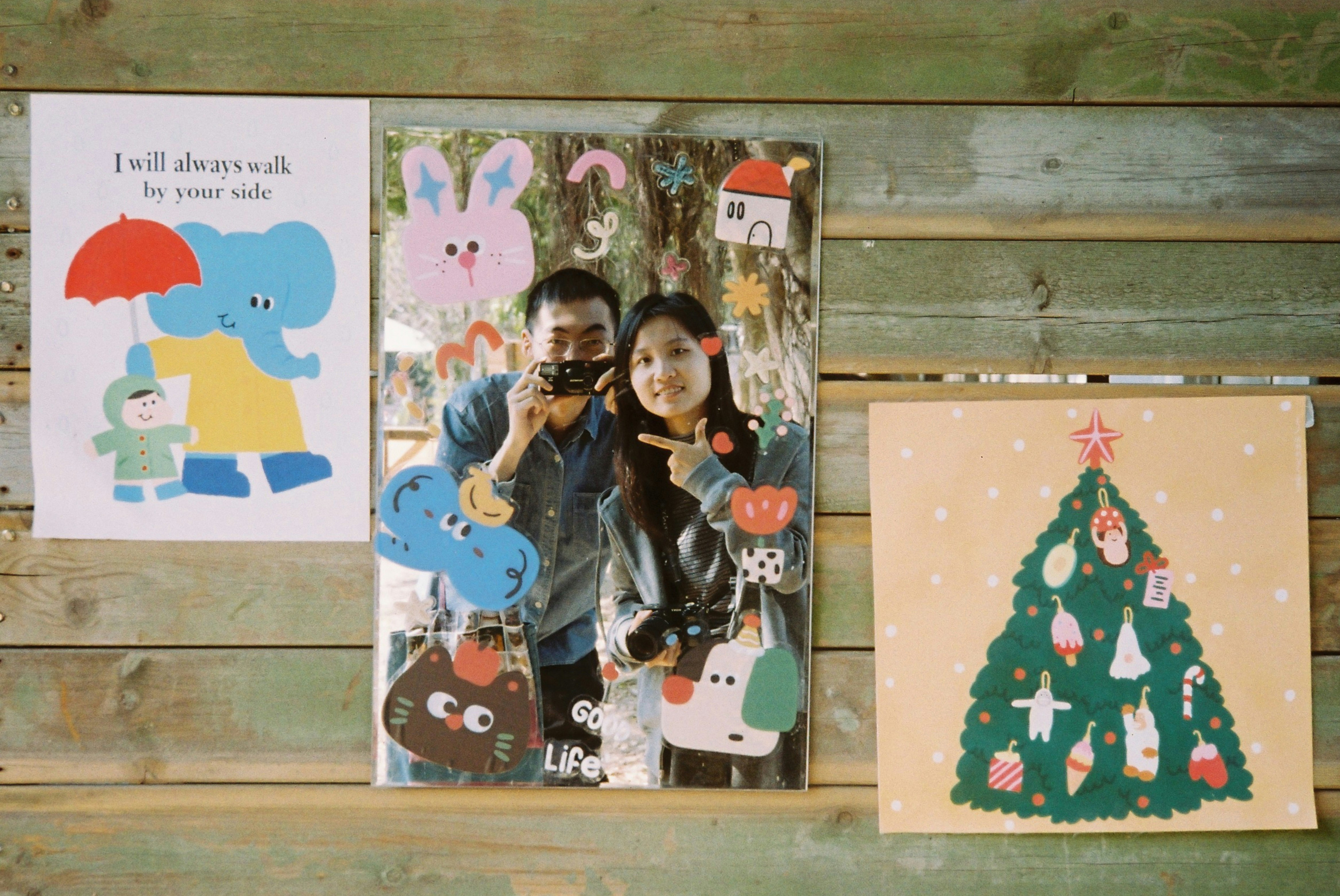 Couple takes a selfie with festive decorations on wooden wall
