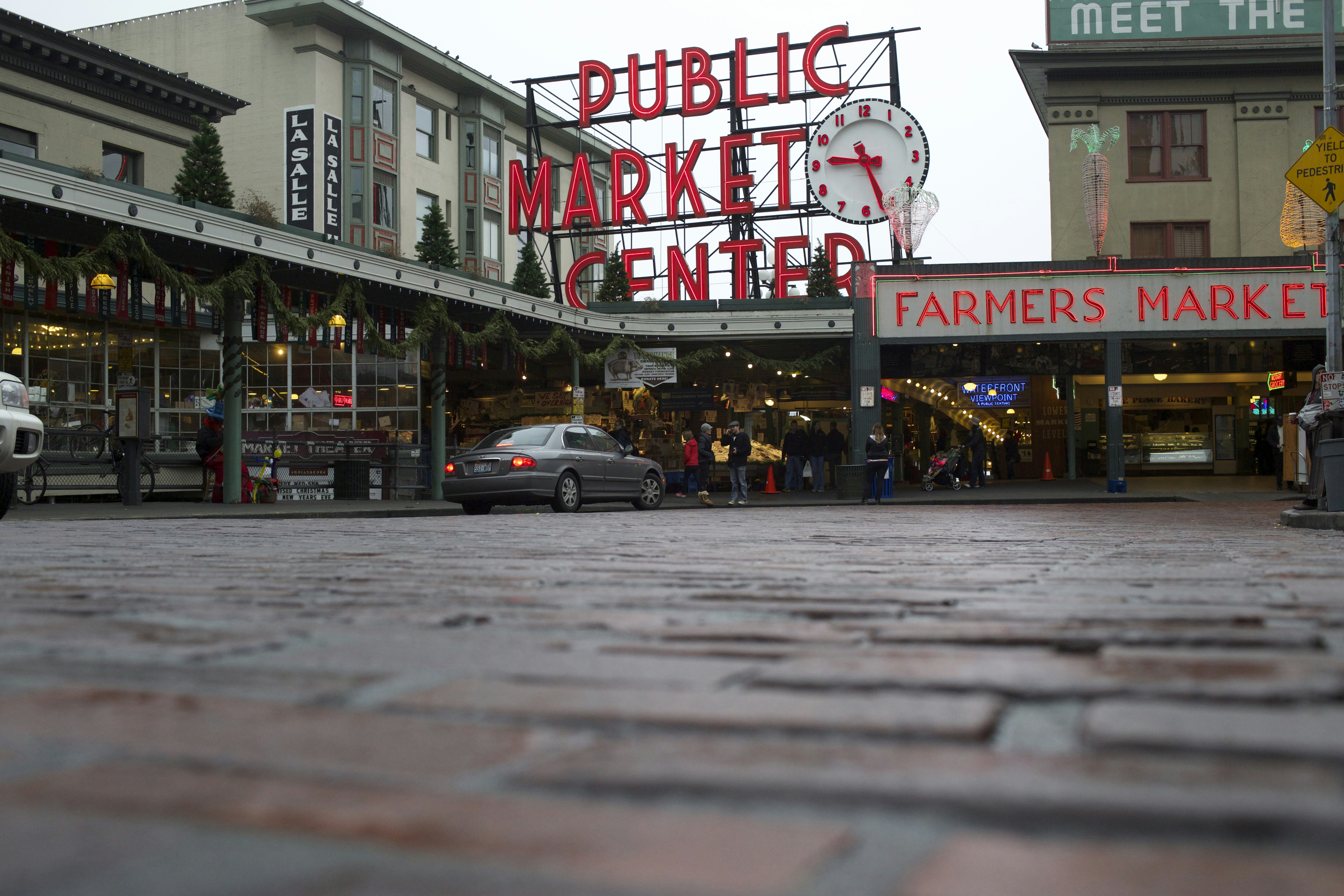 Neon Signage Above a Bustling Market Entrance