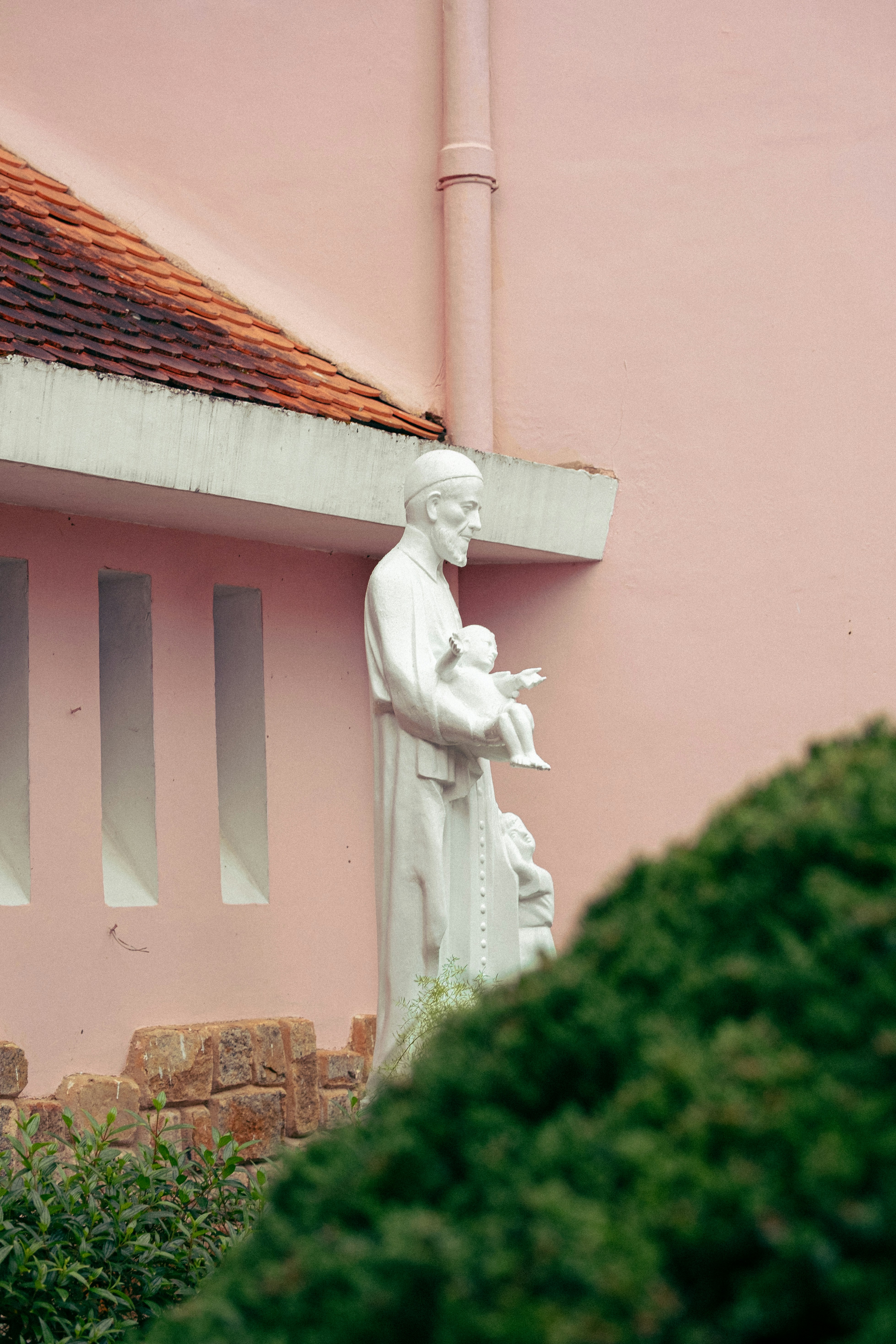 Soft Pink Sanctum: A White Cleric and Child in a Quiet Courtyard