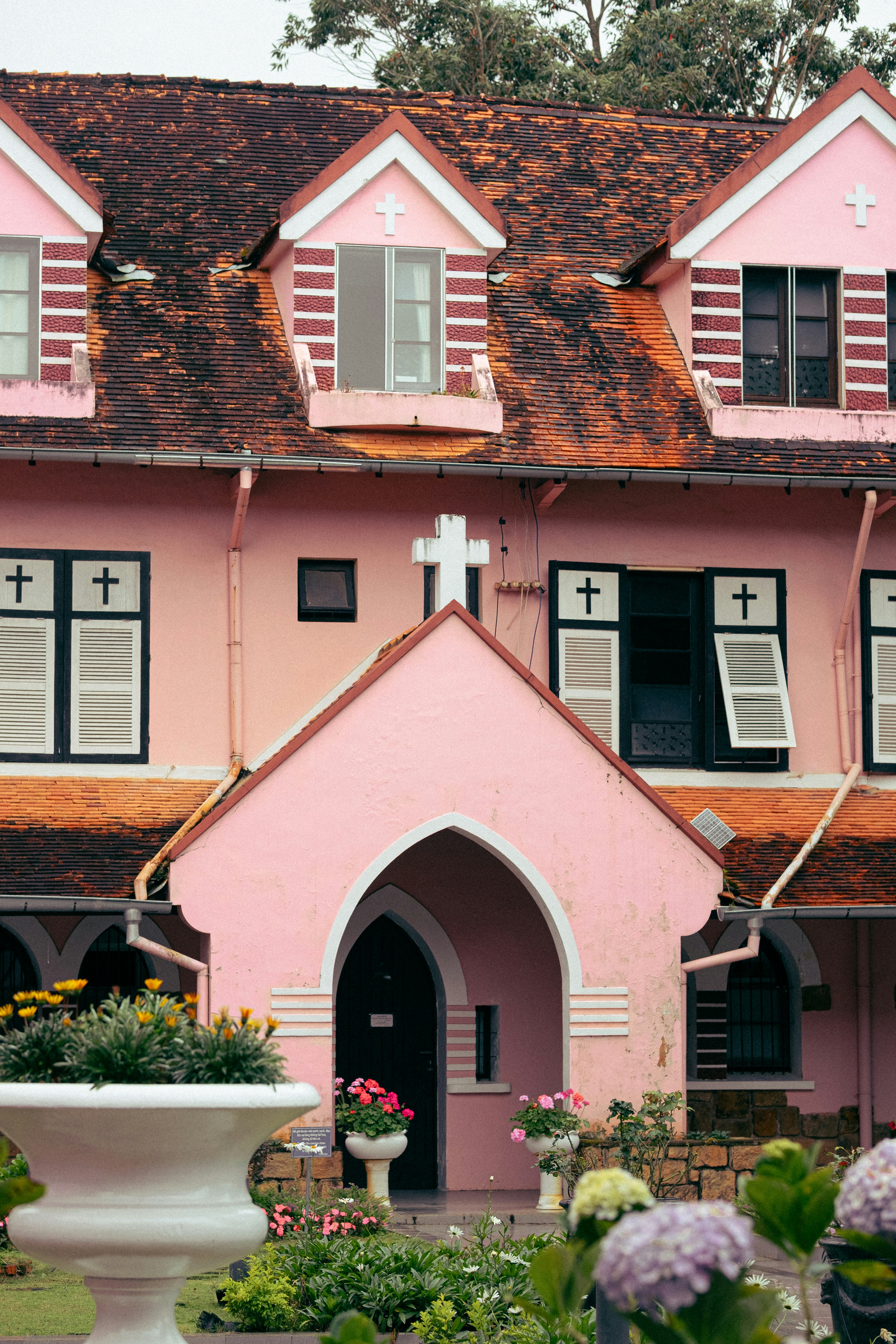 Pink Catholic Courtyard: A Garden Sanctuary Before the Archway
