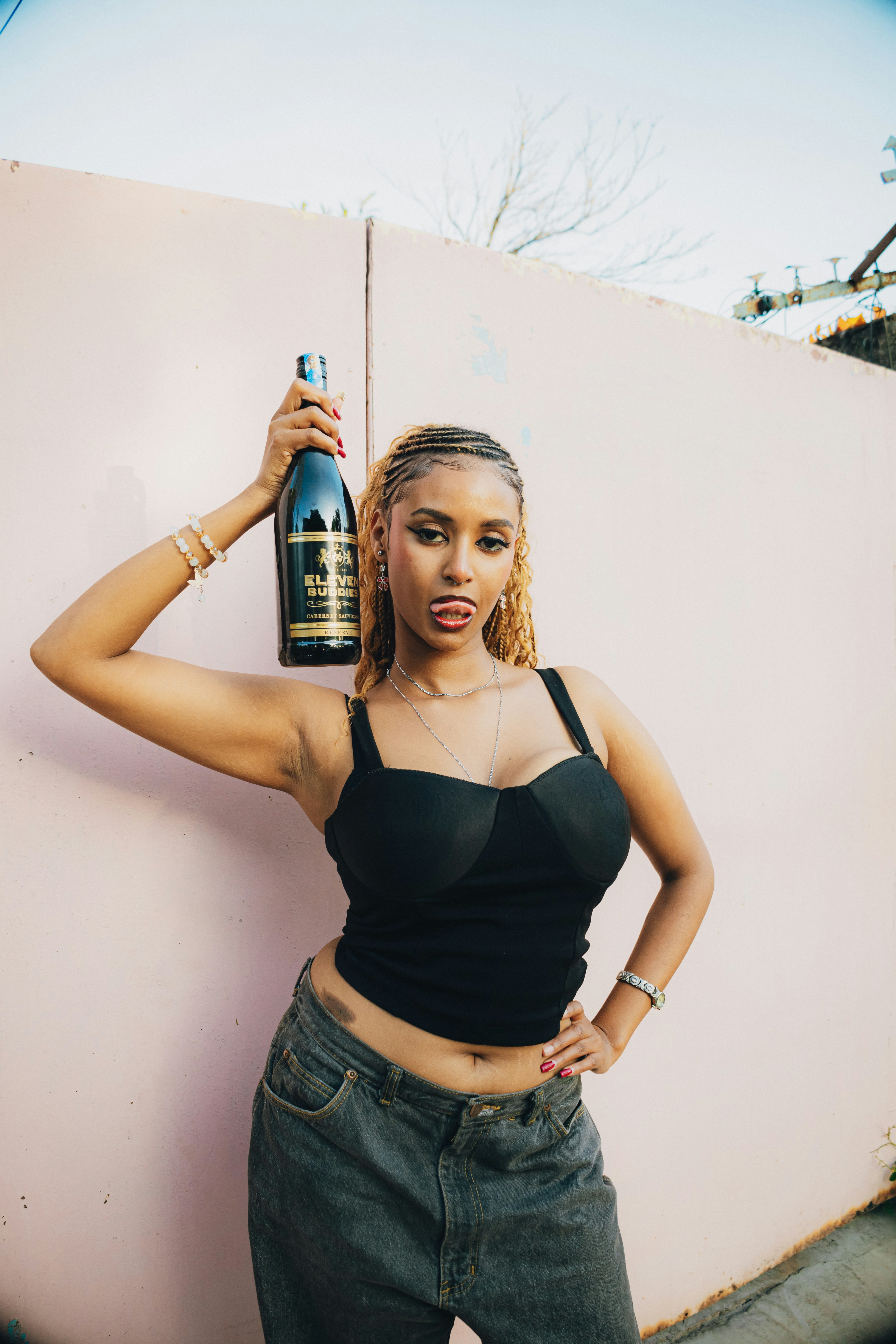 Champagne Confidence: A Bold Portrait Against a Peach Wall