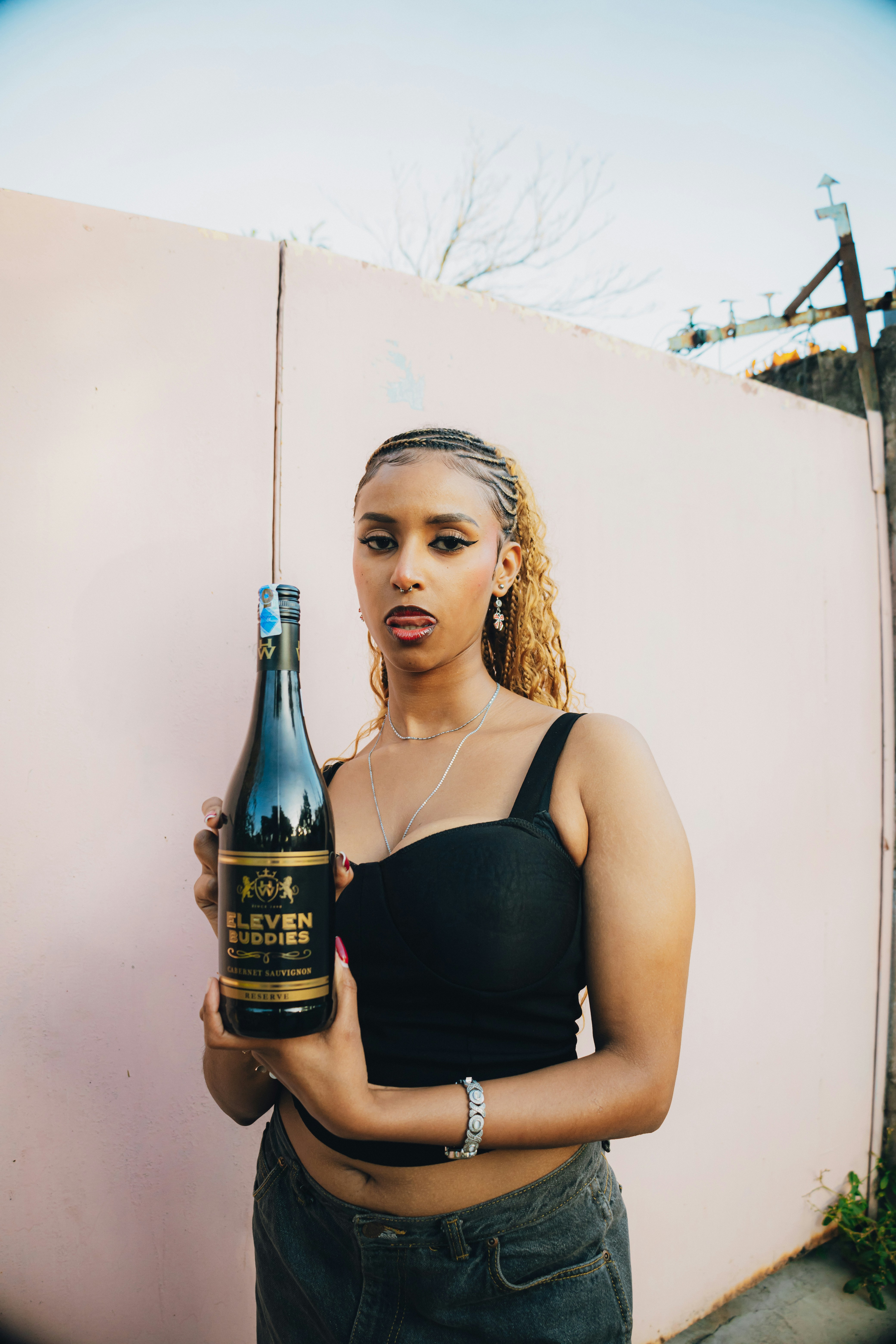 Celebration in a Pink Corridor: A Woman with Bottle of Bubbly