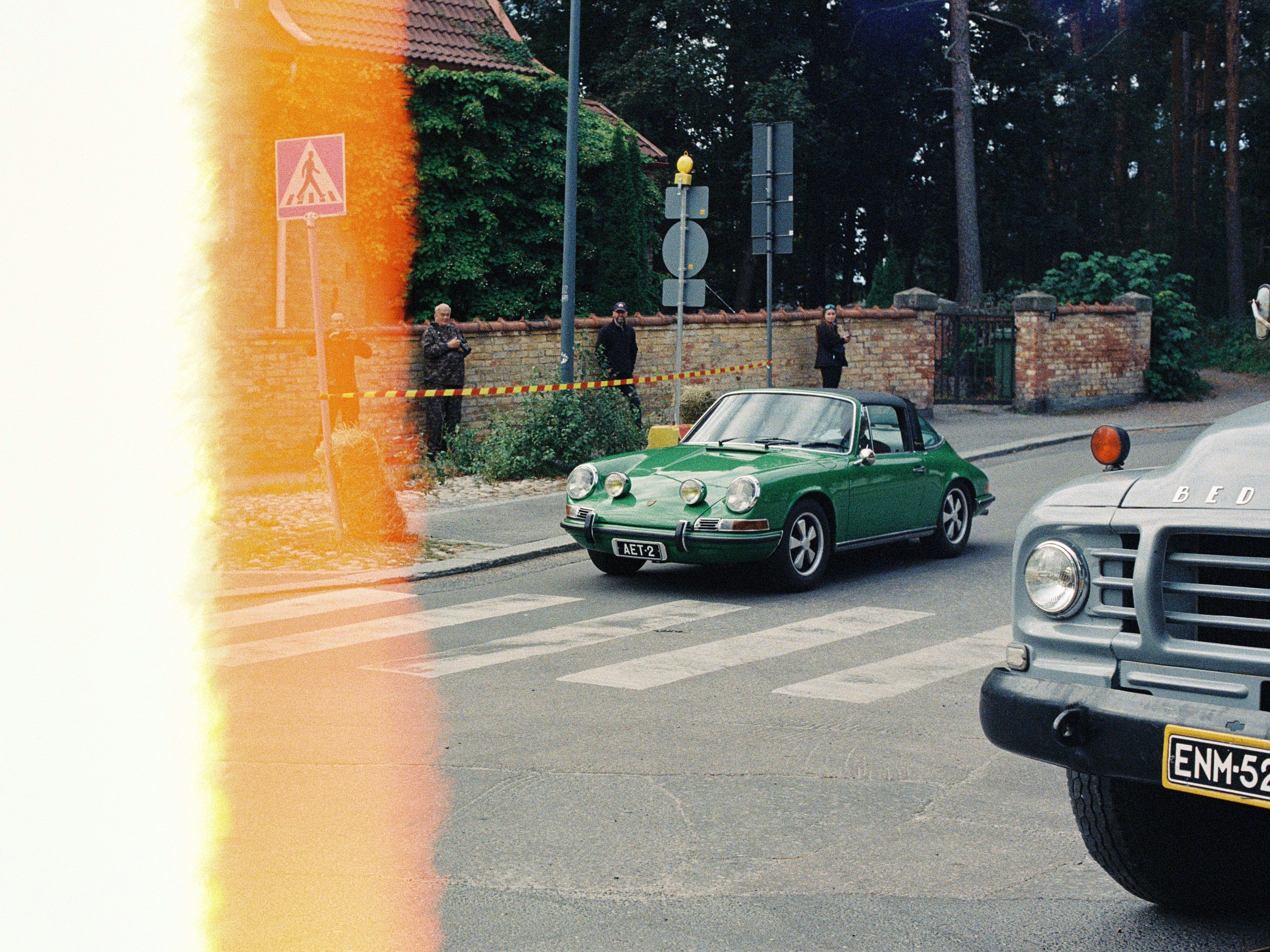 Green Classic on a Crosswalk: A Quiet Moment Between Past and Present