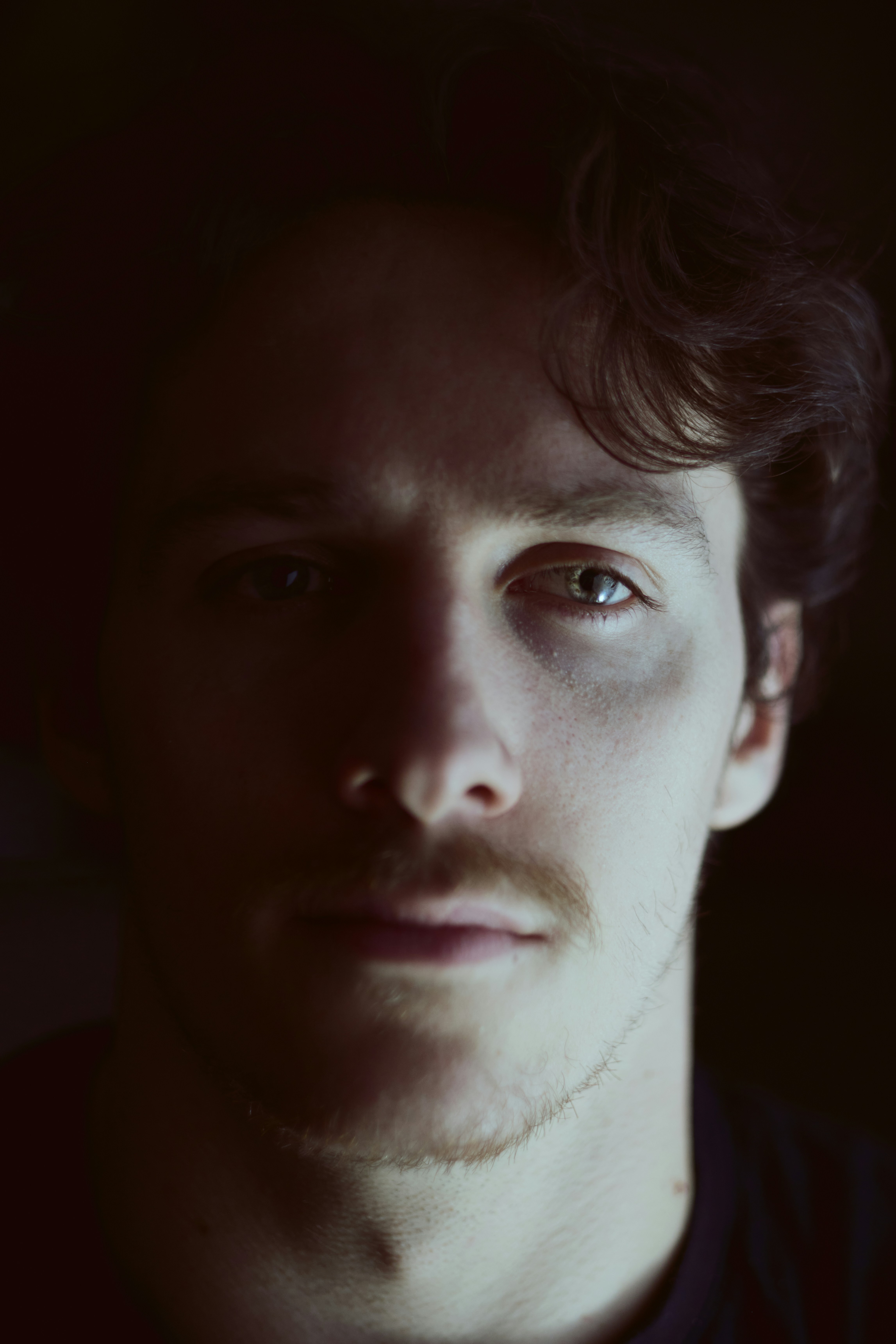 Shadowed Gaze: A Quiet Portrait in Low Light