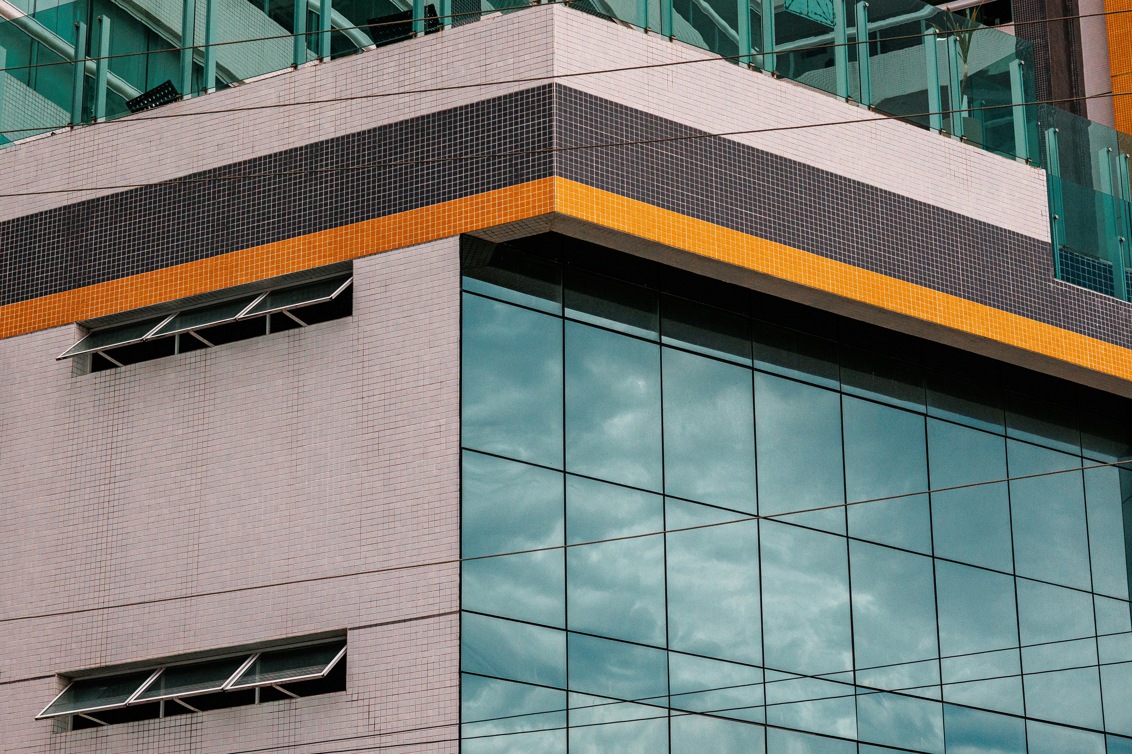 Glass Facade Lines and Orange Stripe: A Modern Building Detail