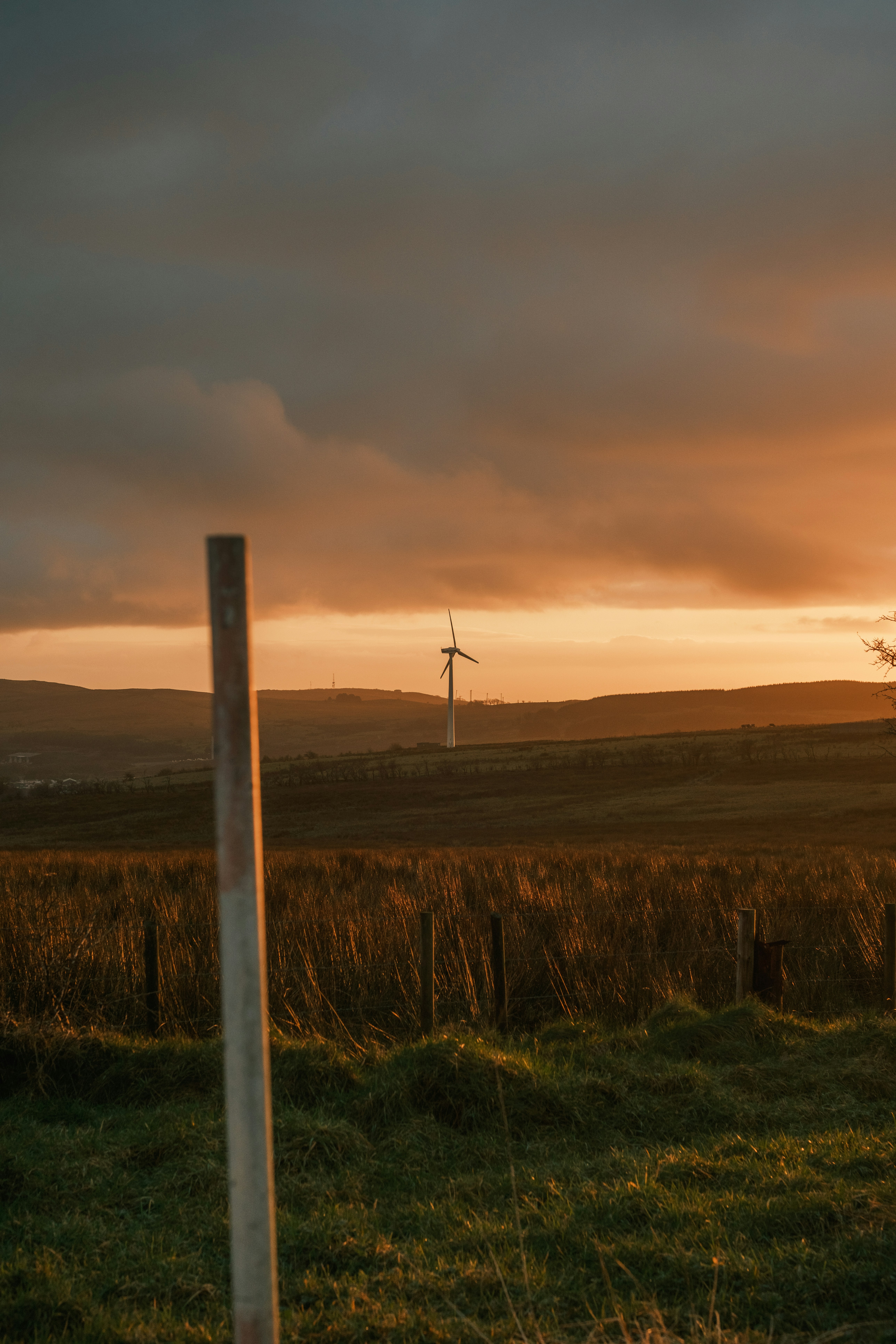 Sunset Fence and Windmill: A Quiet Horizon