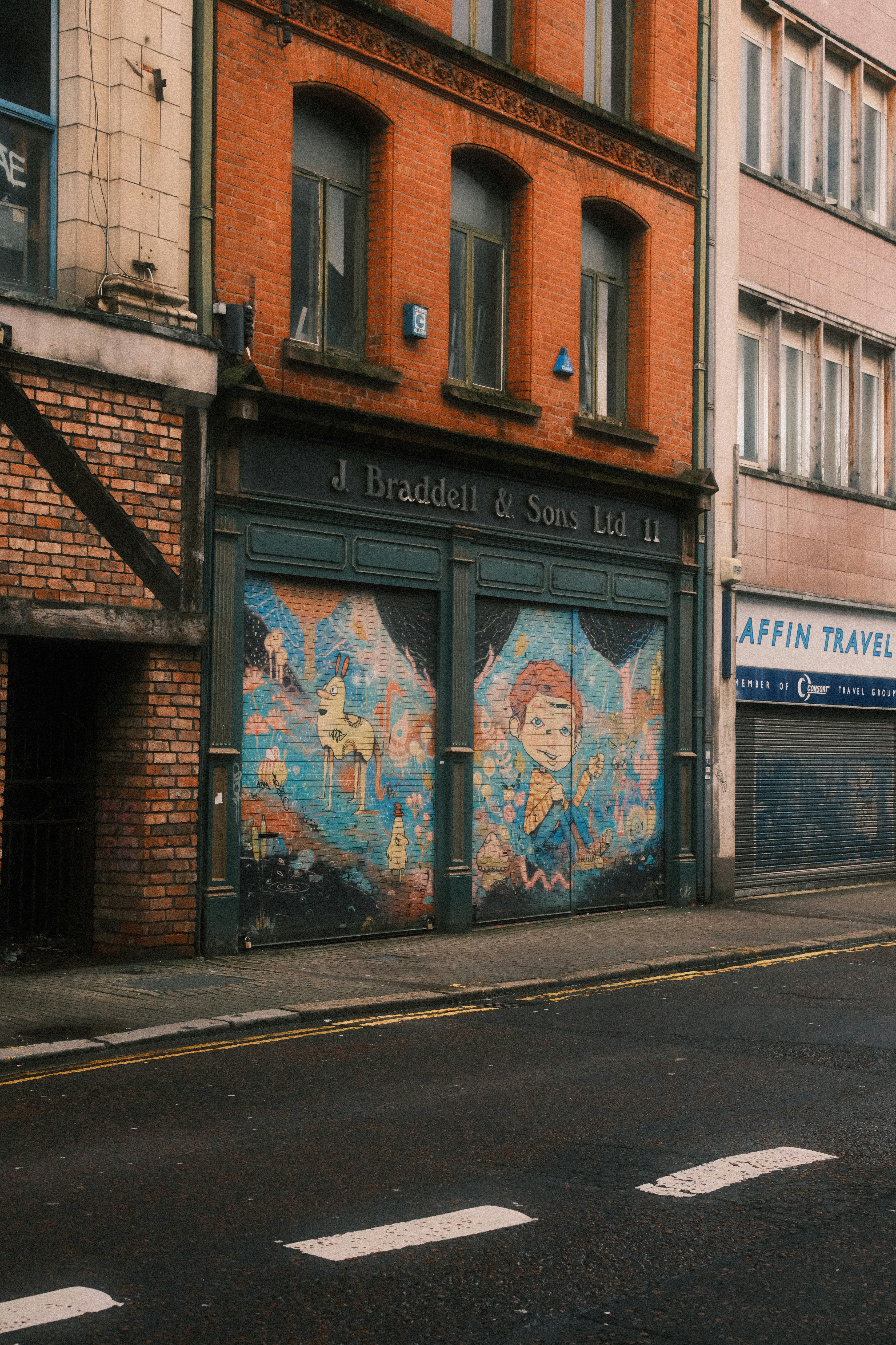 Muraled Facade: A Street-Level Glance at a Closed Shop