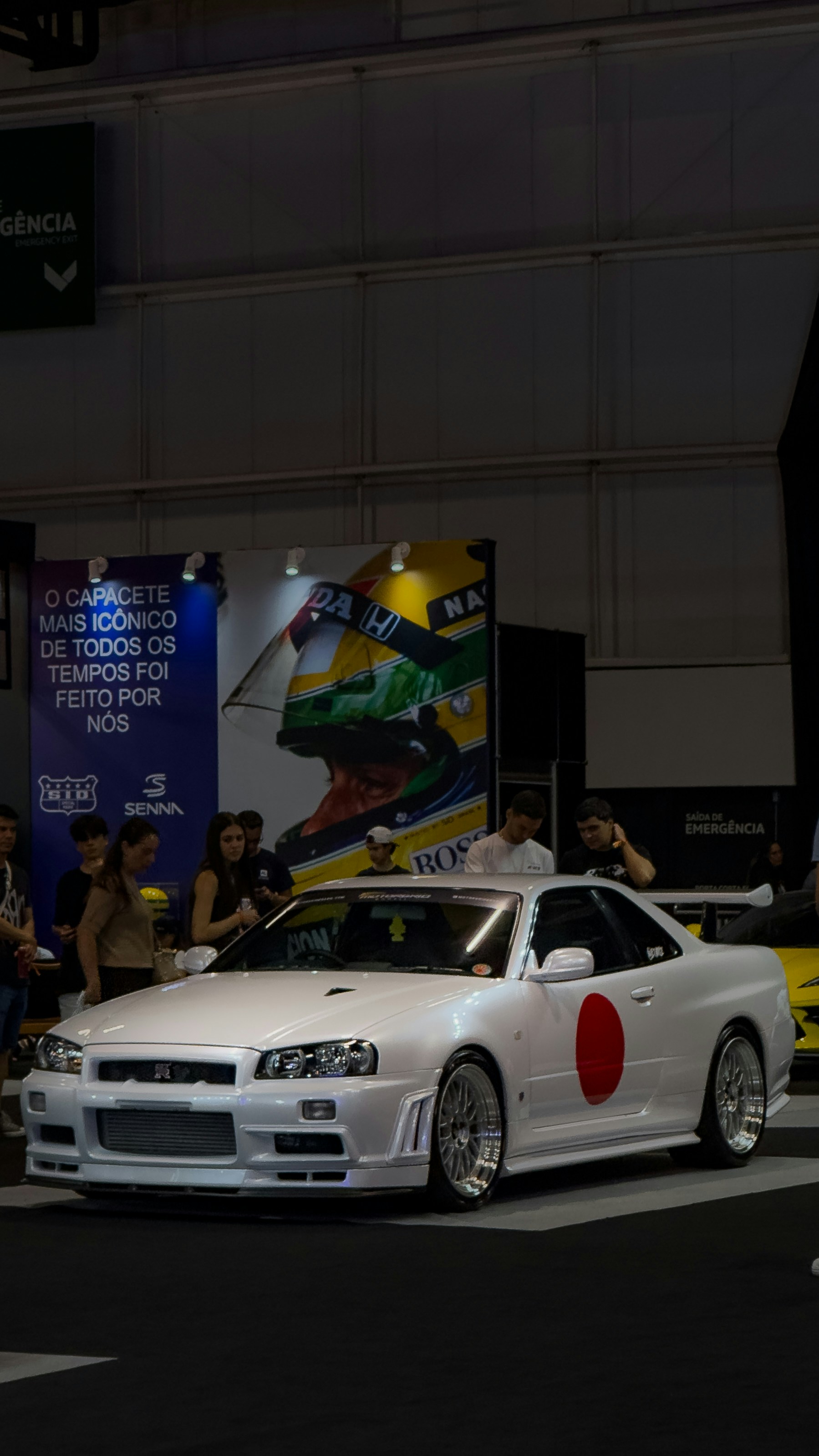 White Nissan Skyline on exhibition floor with Japanese flag circle