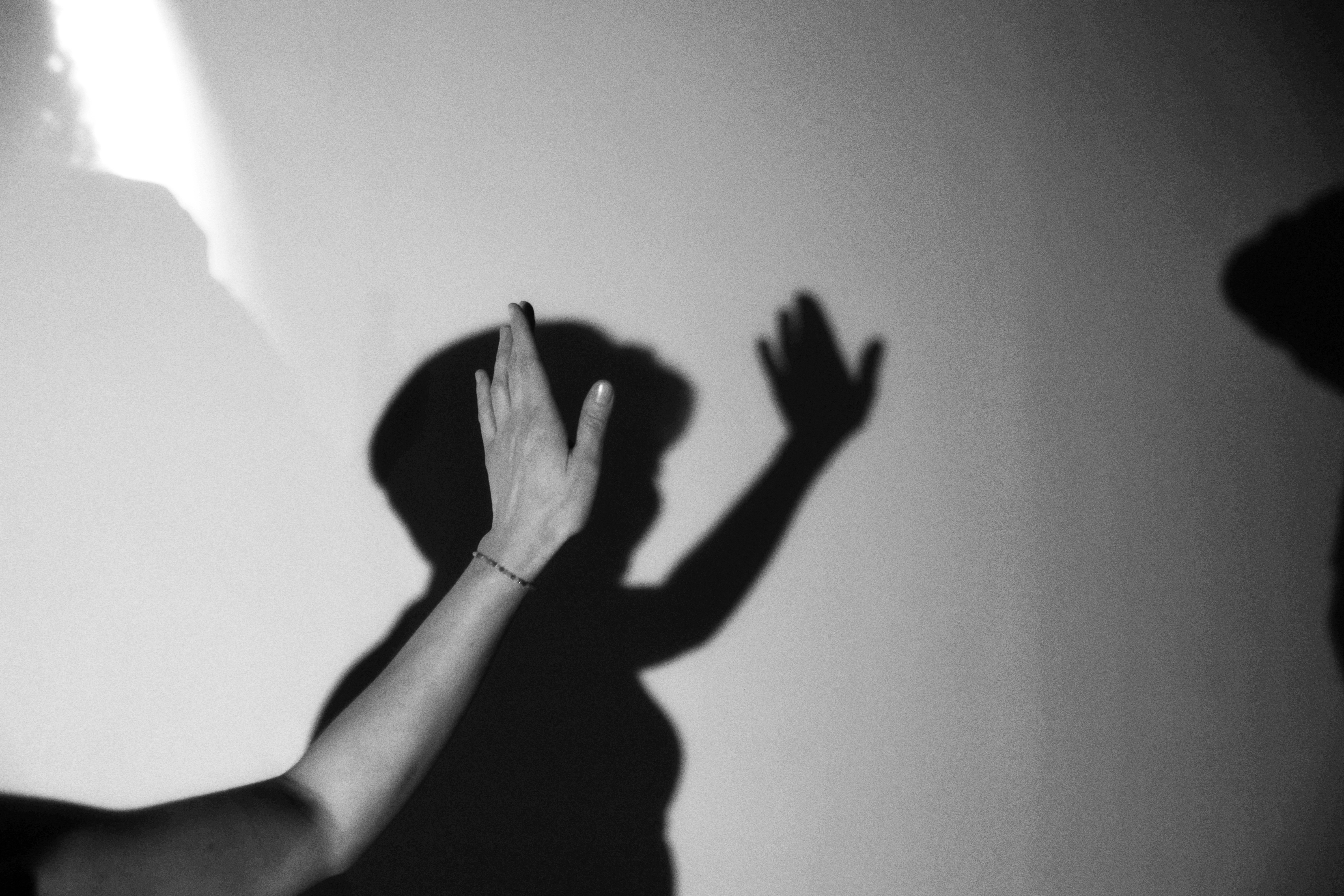 Shadow Play: A Raised Hand Halts the Light