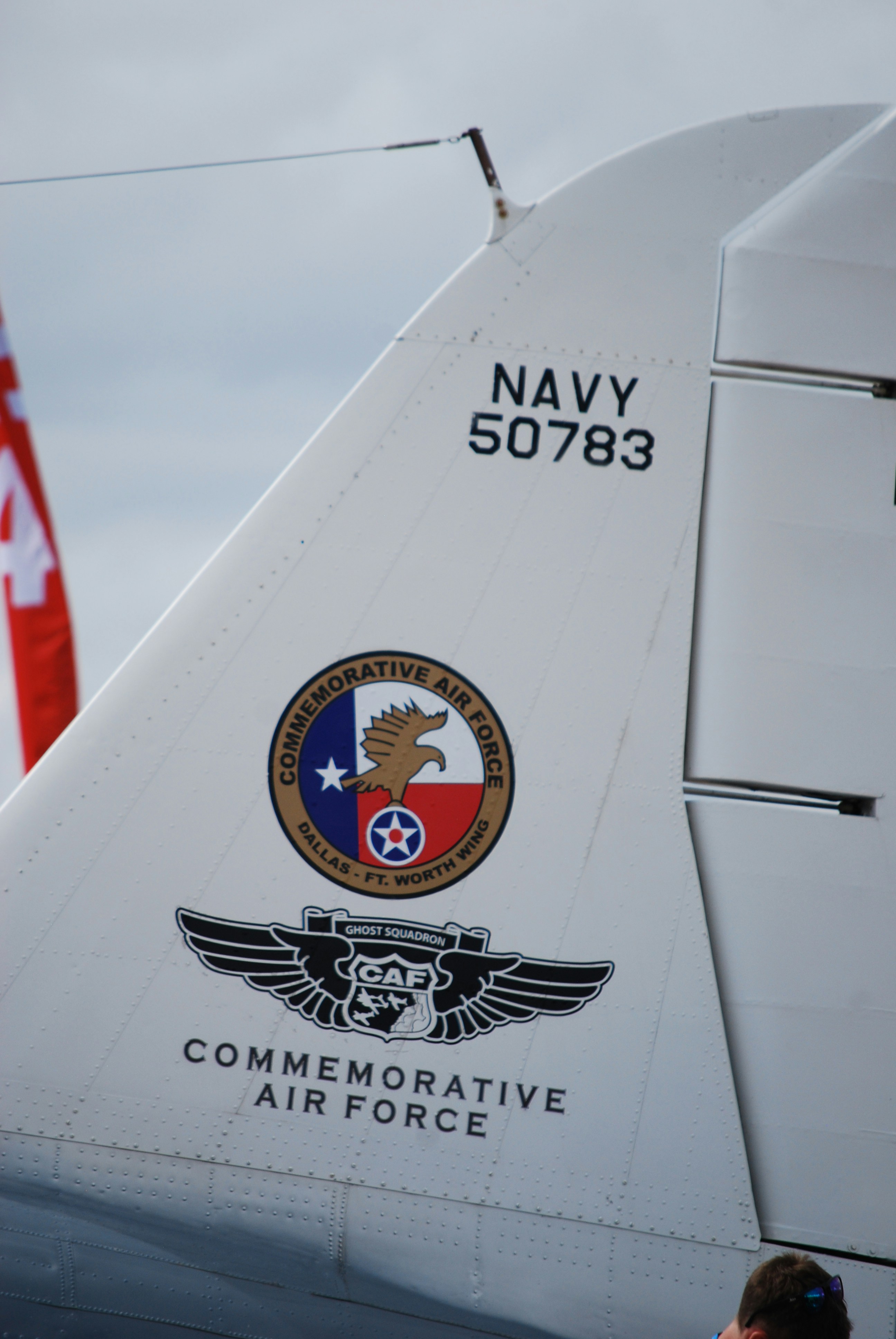 Emblem and Tail Soaring: Commemorative Air Force Insignia on Navy Jet Fuselage