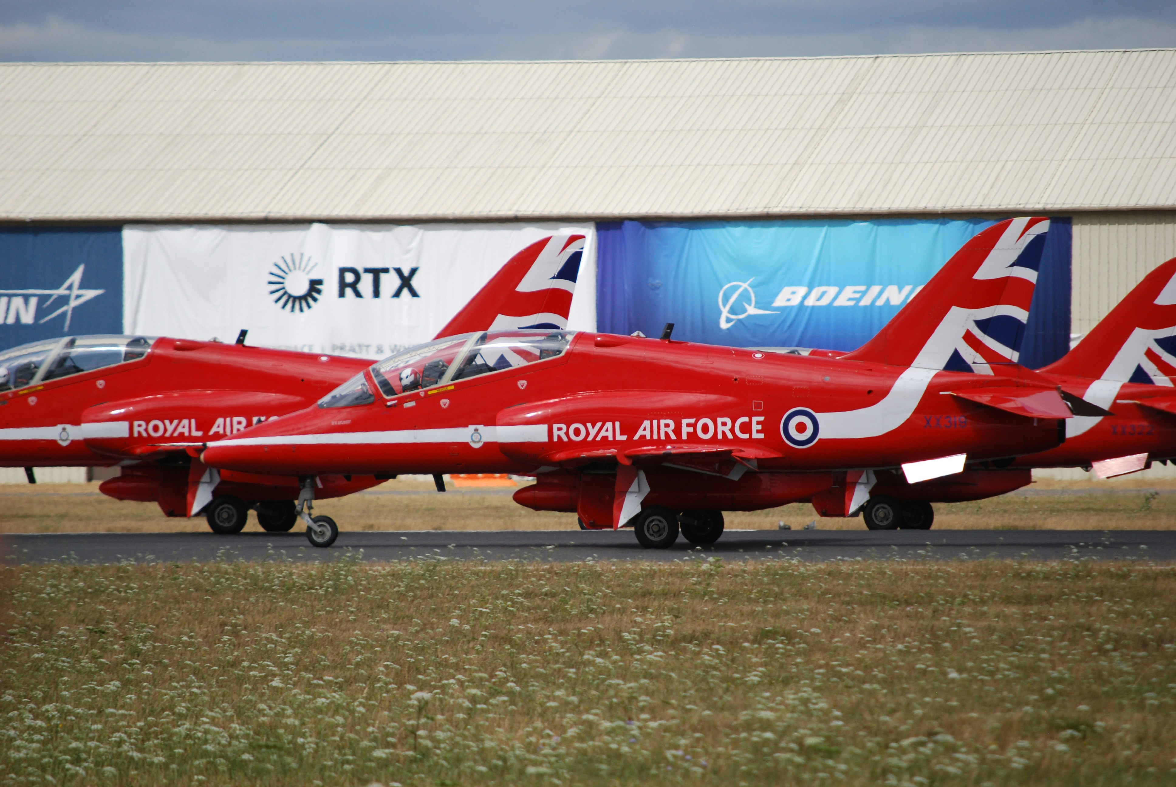 Royal Echoes: Red Jets Rest on the Tarmac