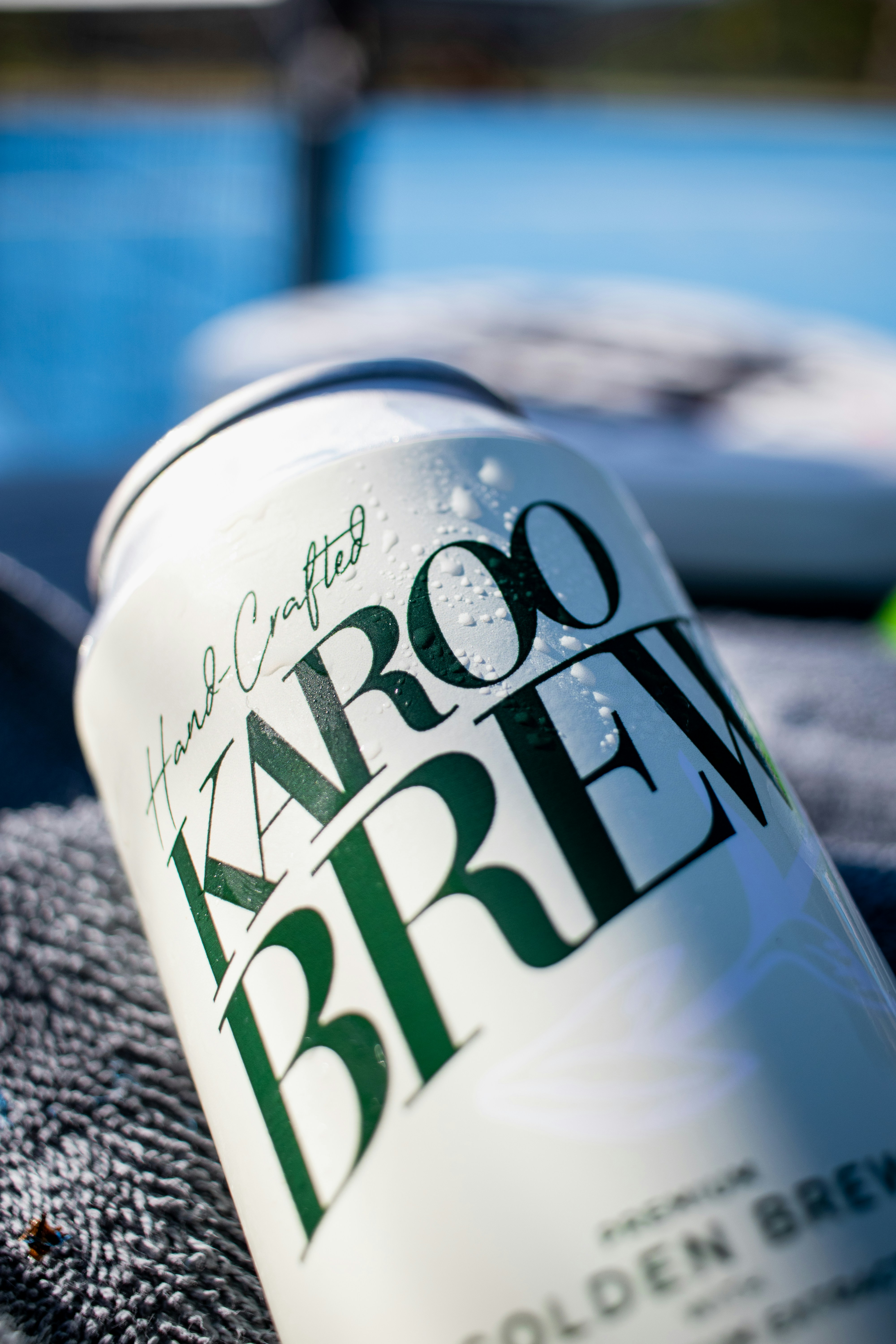 Soda on the Shore: A Can of Golden Brew by the Poolside