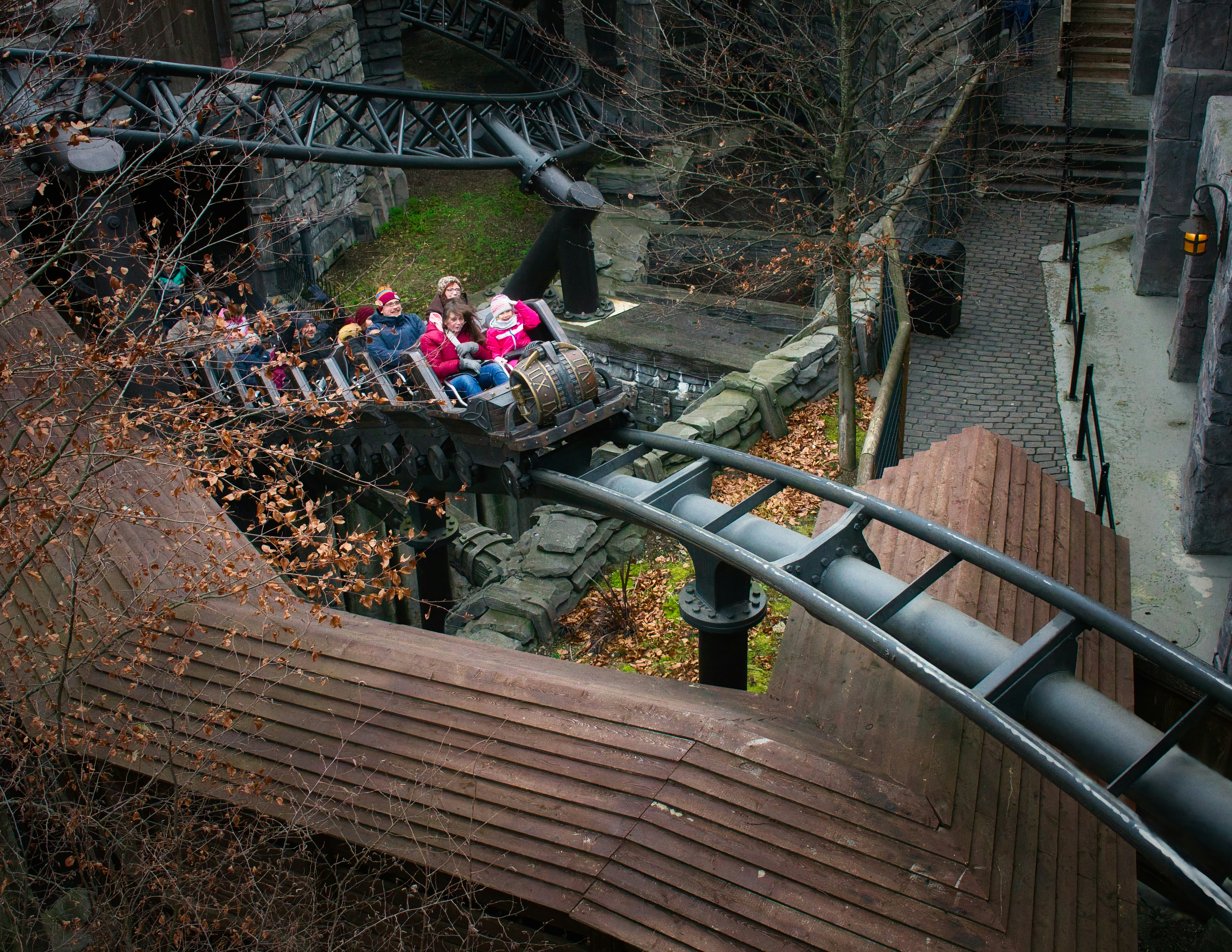 Riders in the Elevated Track: Aerial View Through Rustic Railings