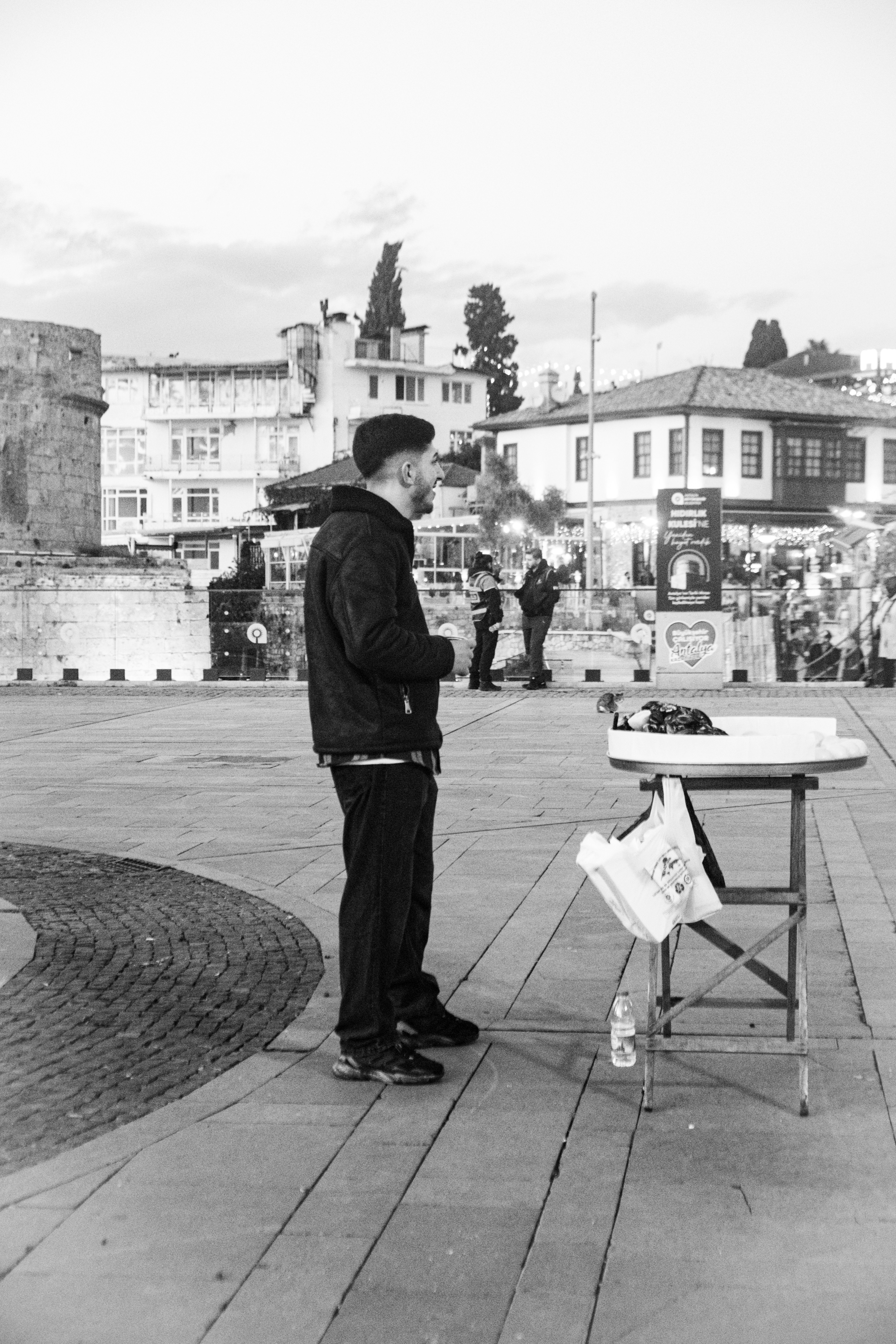 Street Performer Portrait: Man in Profile by a Table of Props