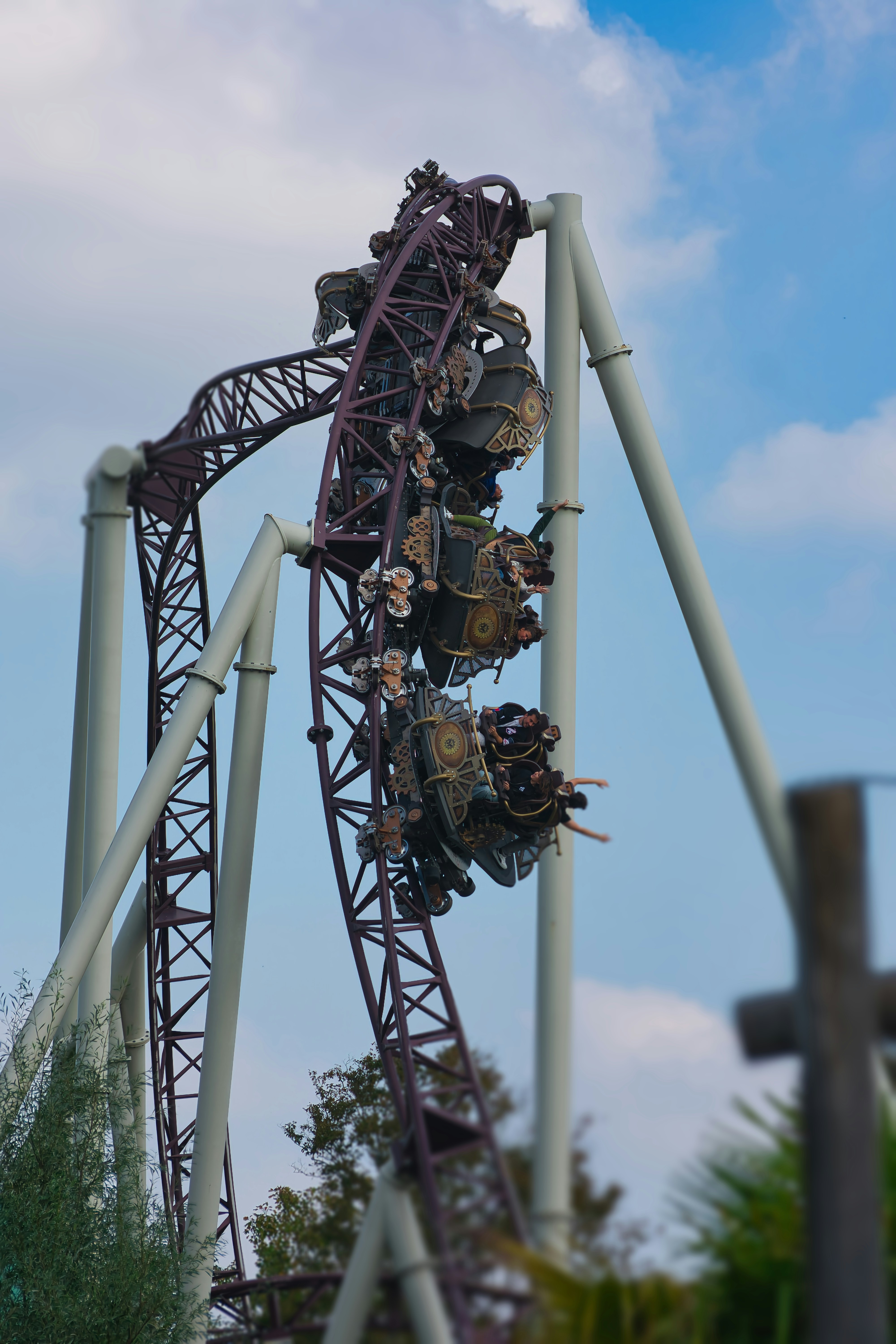 Juxtaposed Loop: Riders Cling to a Purple Coil as the Track Dives