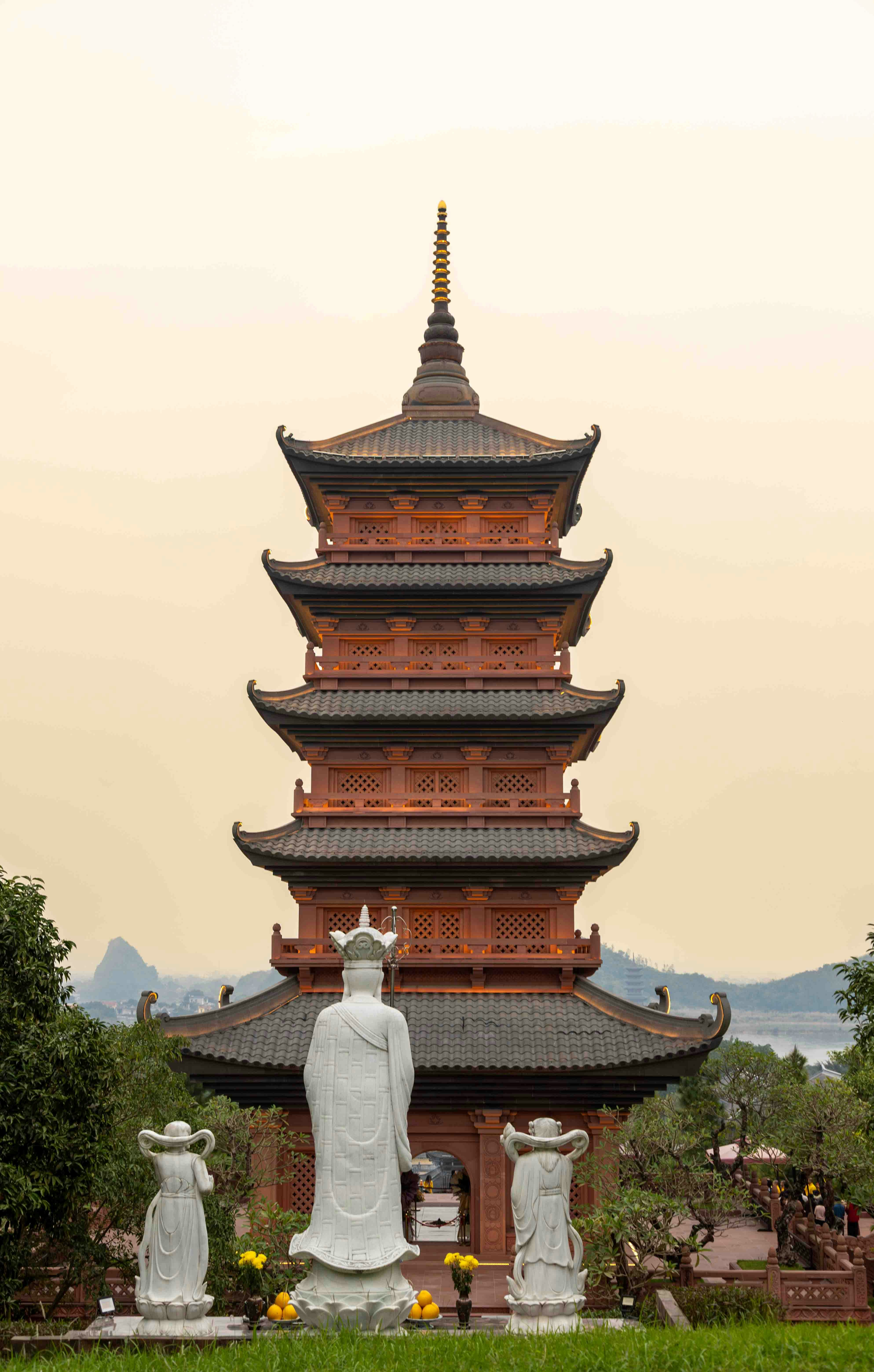 Pagoda in Soft Dawn Light Framed by White Statues
