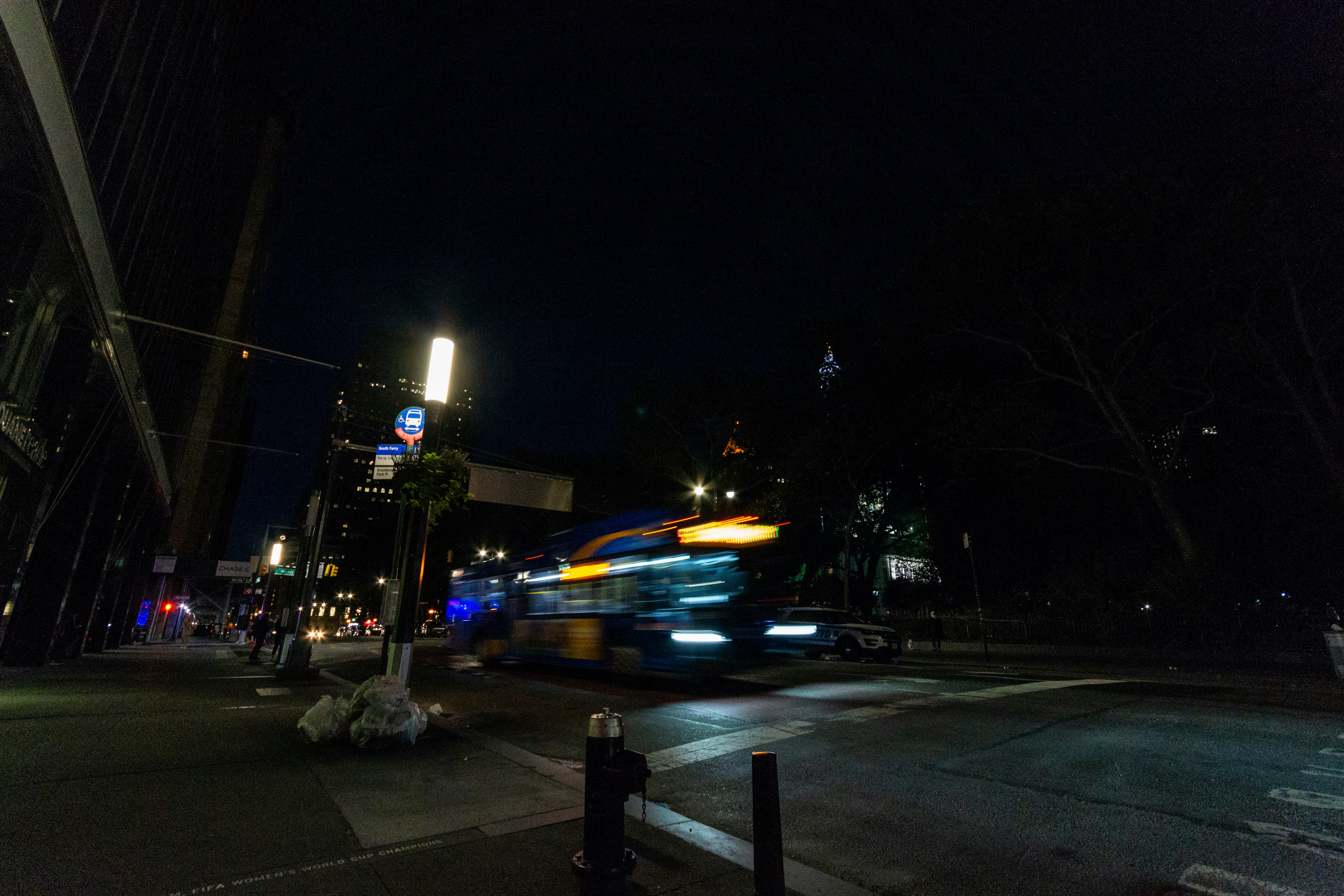 Night City Street Streaks: A Moving Bus in Blur and Neon