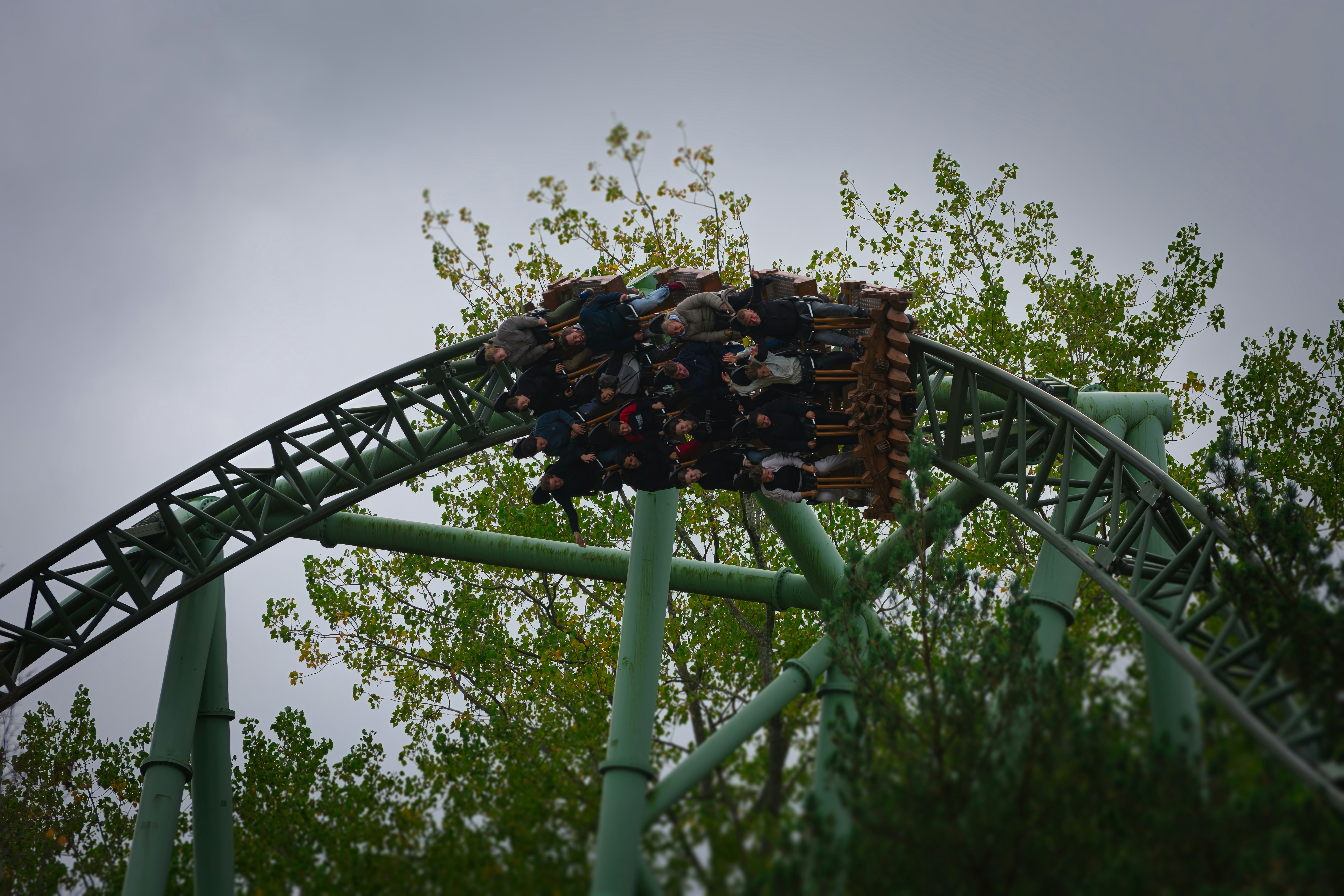 Mid-Span Thrill: Riders Crest Over the Green Steel Arc