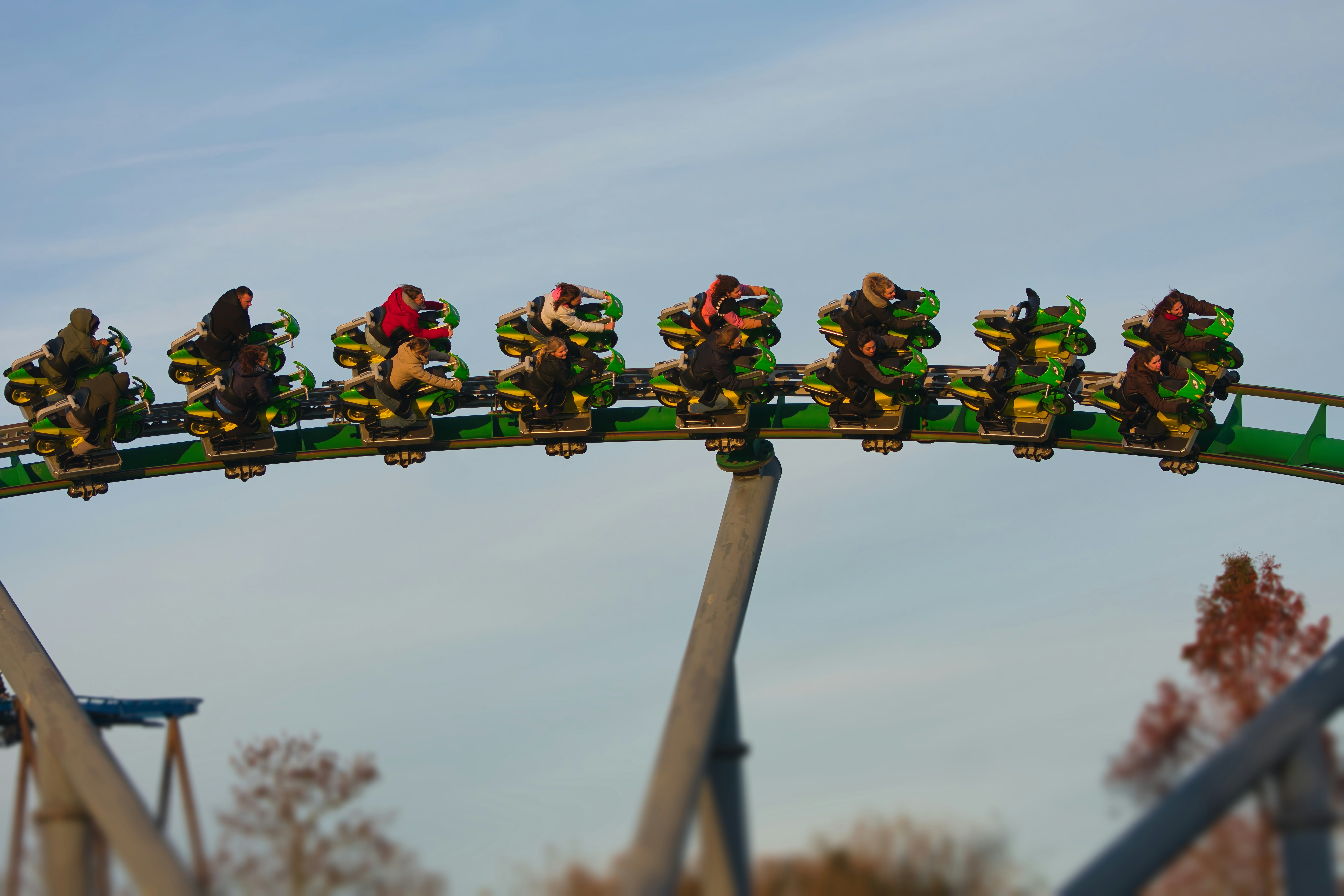 Mid-Race Momentum: Green and Red Cars Fly Over the Crest