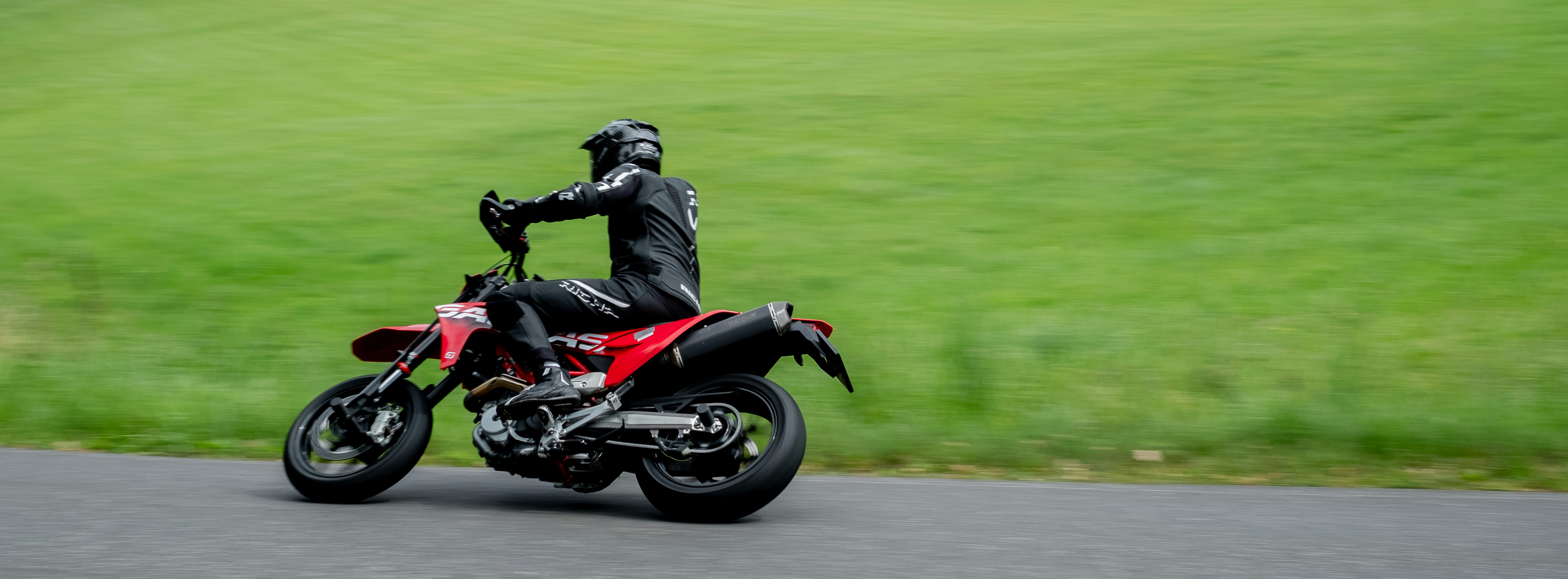 Red Blaze on the Road: A Rider in Motion