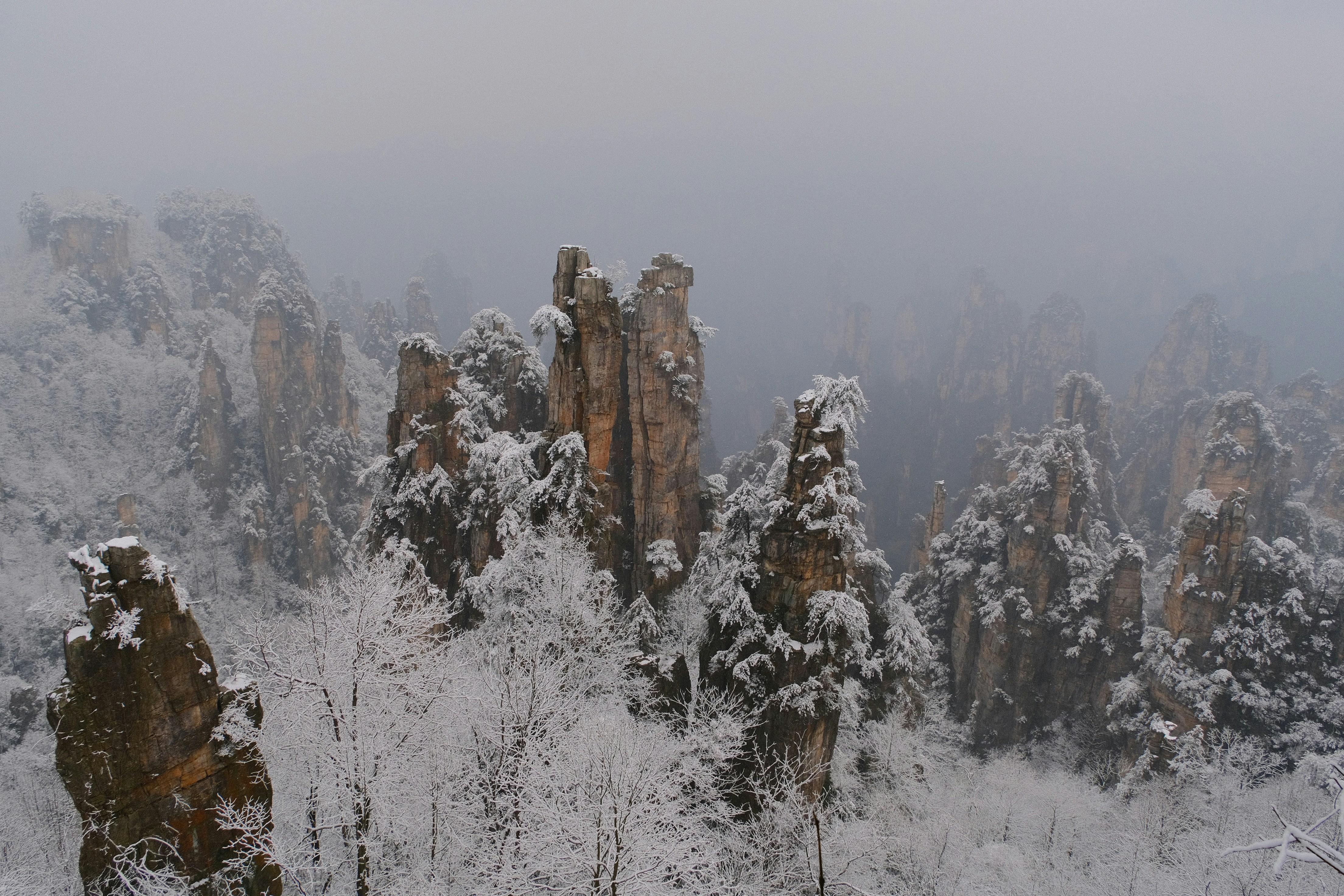 Frozen Guardians: Snow-Capped Spires in Mist