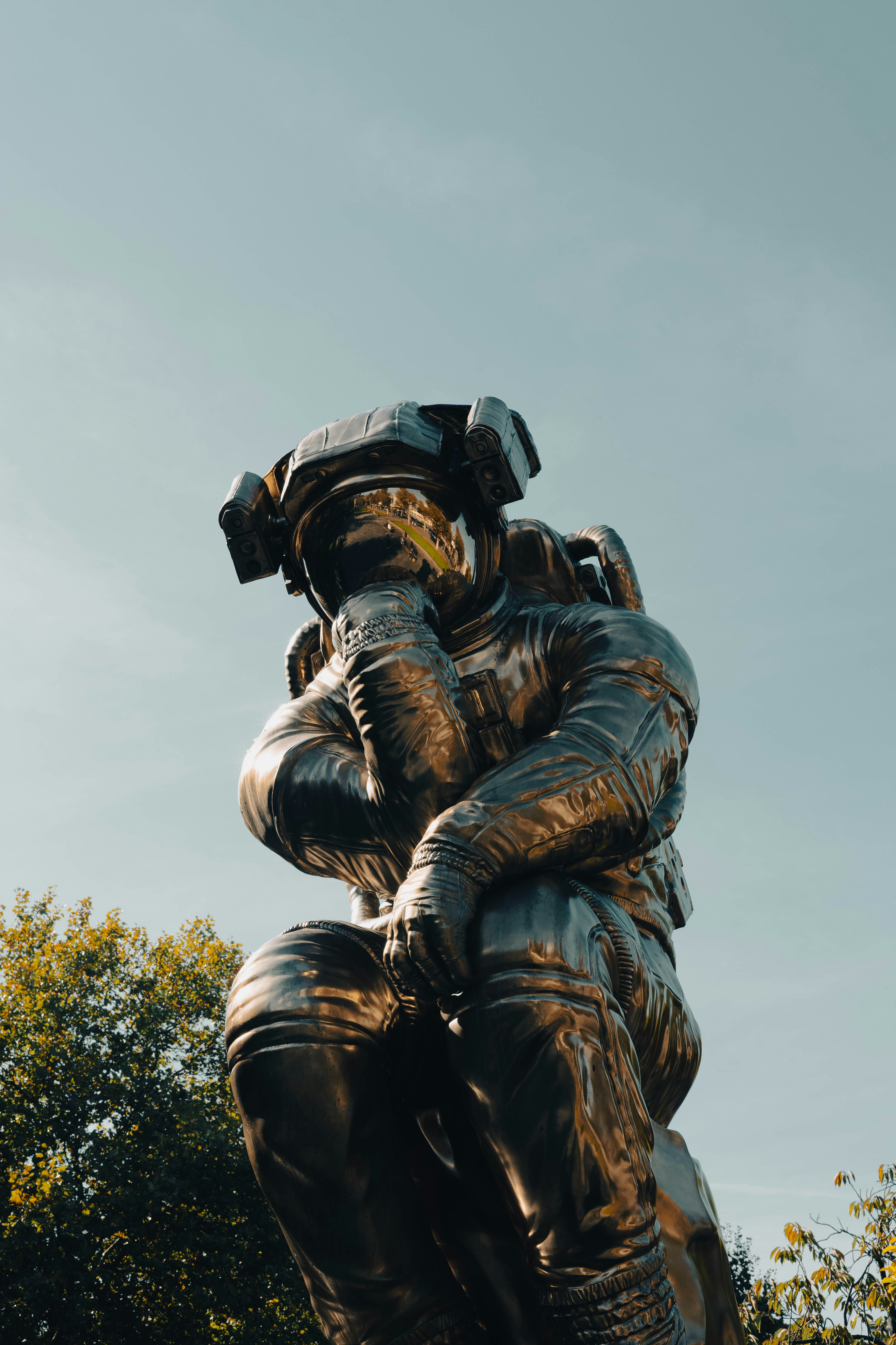 Gazing into the Sky: A Bronze Astronaut Stands Against the Evening Light