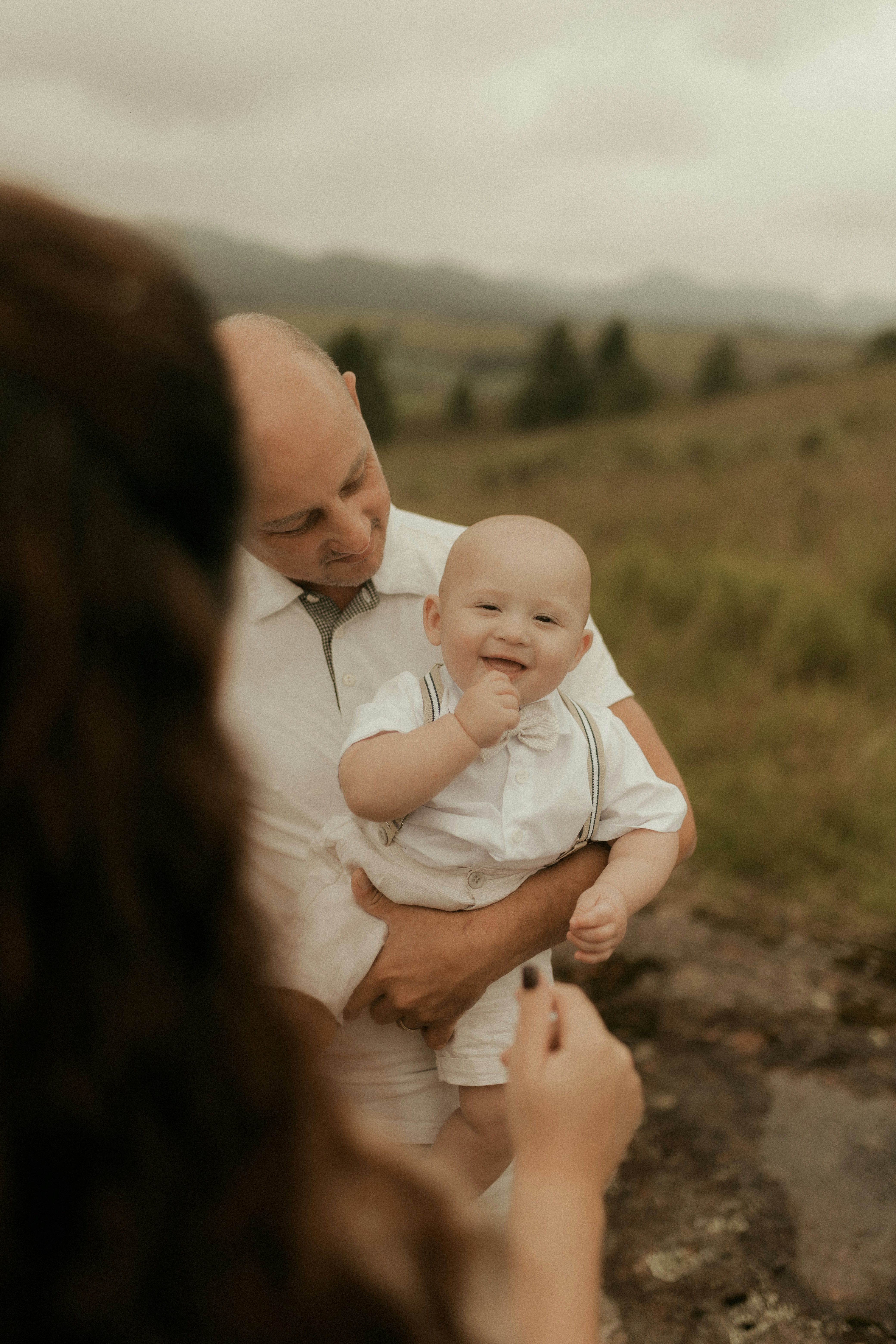 A Tender Moment: Father with Baby in a Sunlit Field