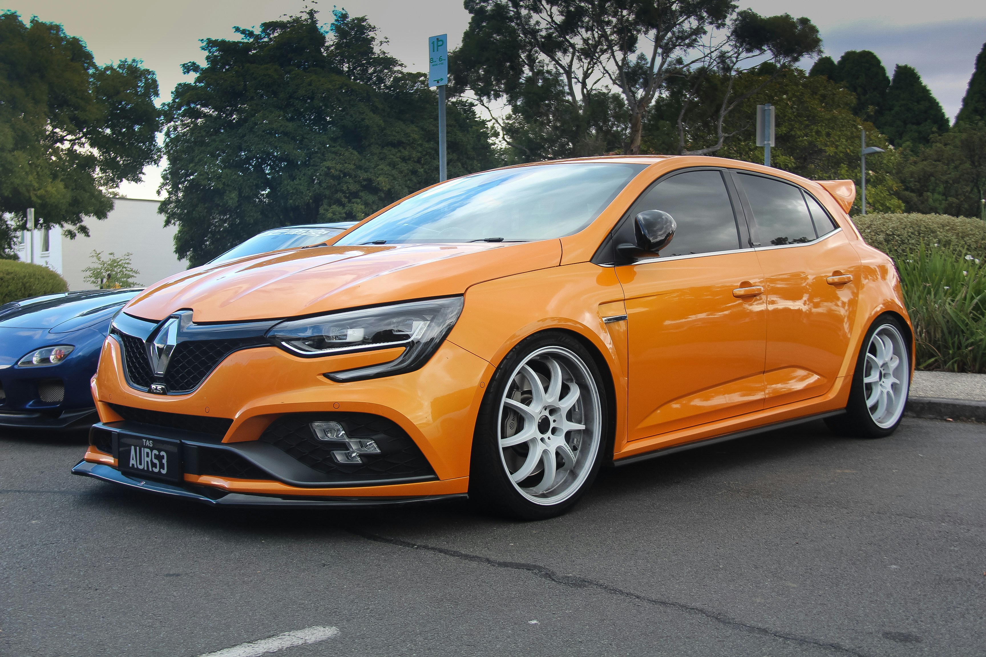 Orange Rocket: A Low-Slung Renault Stance in Parking Lot