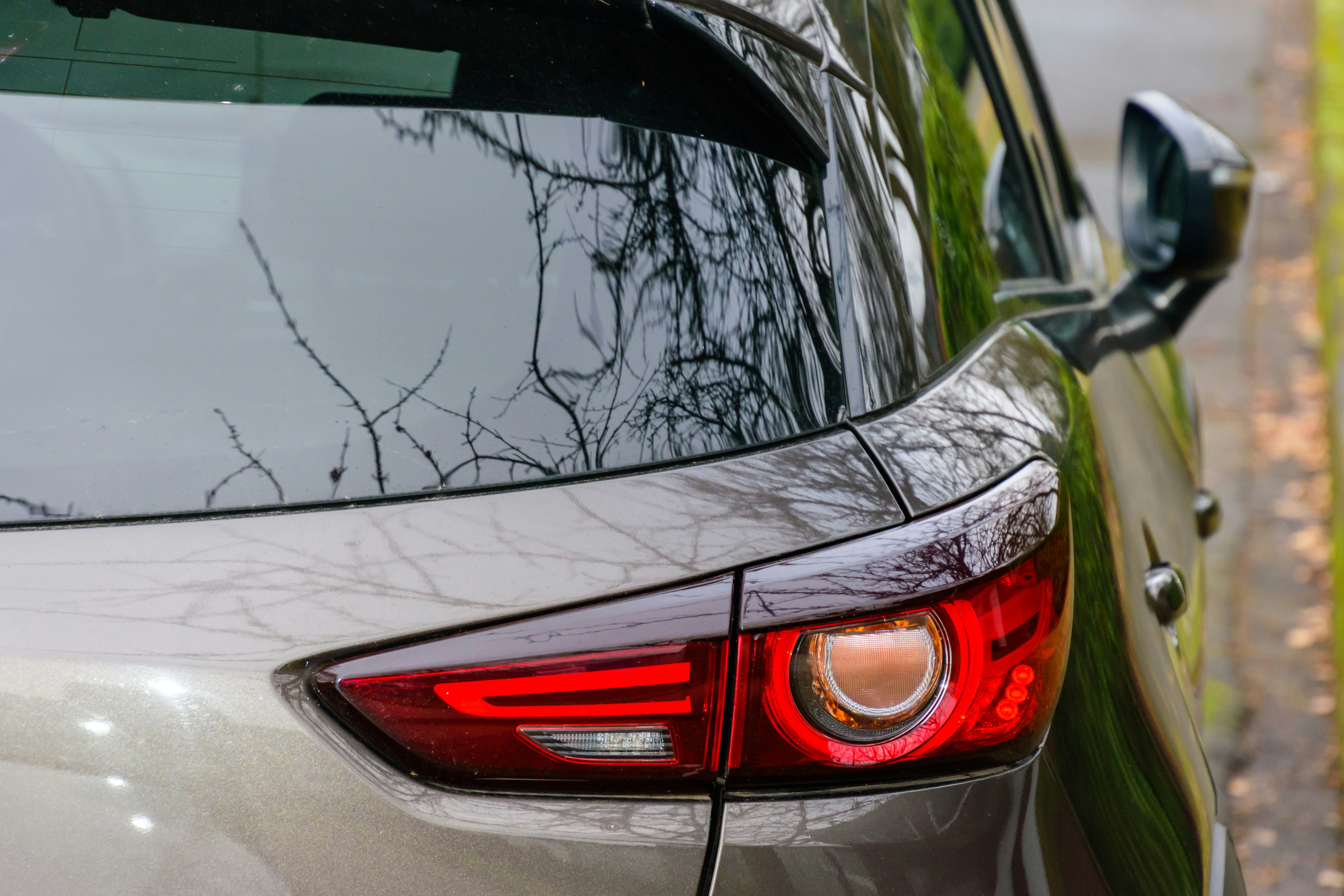 Tail Light Symphony: Red Accent on a Silver SUV at Roadside