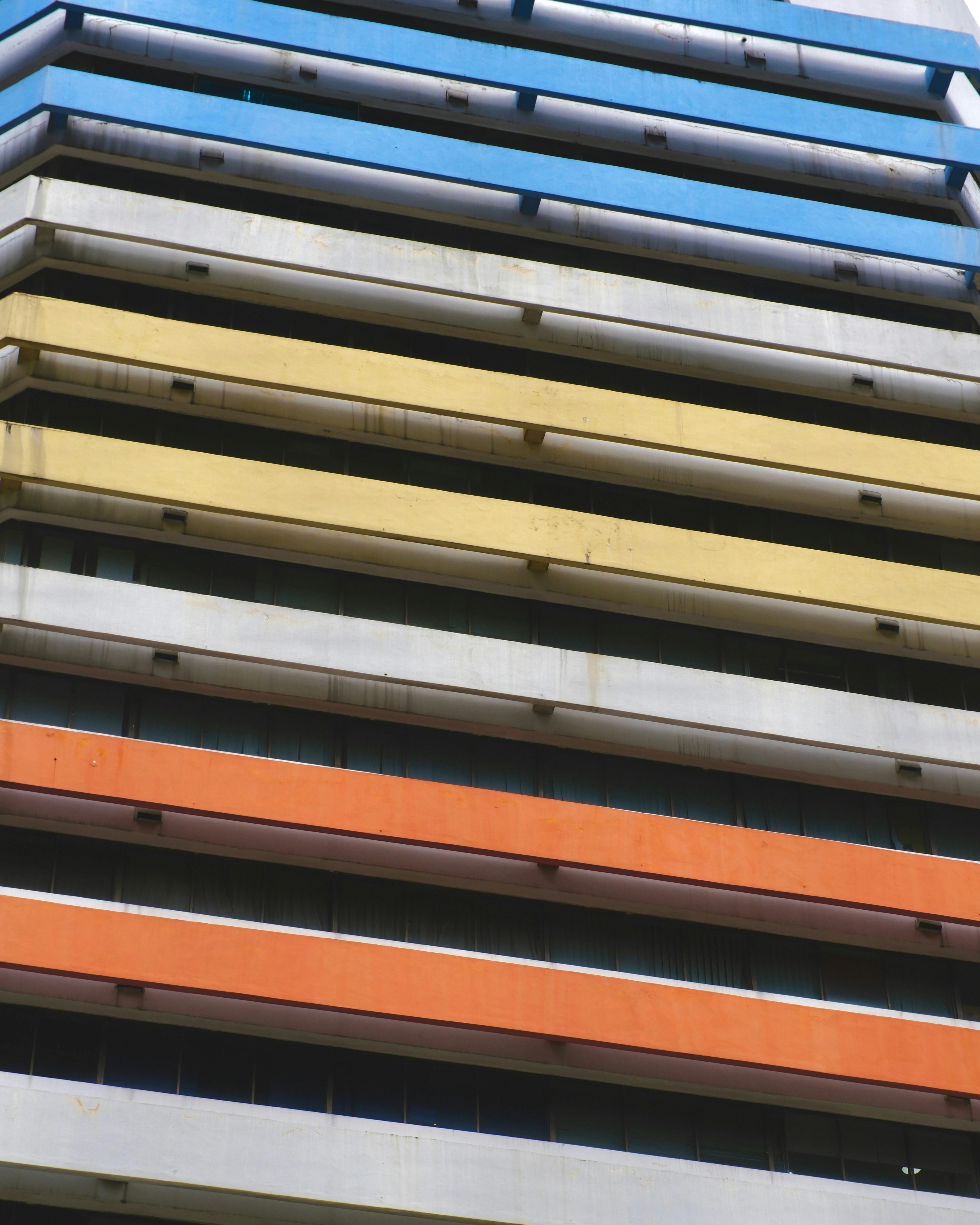 Rainbowed Facade: A Vertical Symphony of Color on a Residential Stack