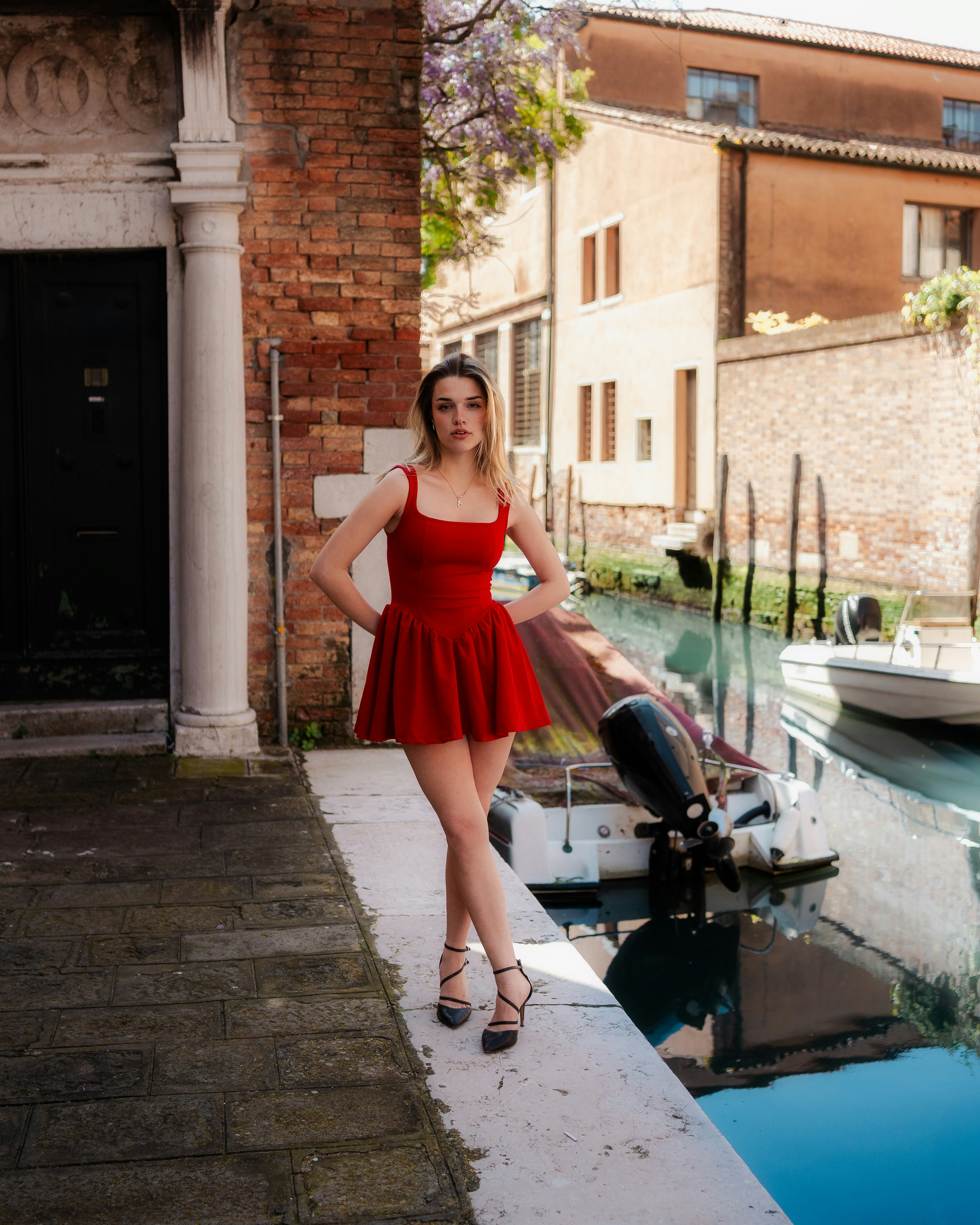 Red Dress at the Canal: A Quiet Pose by Venetian-Style Facades