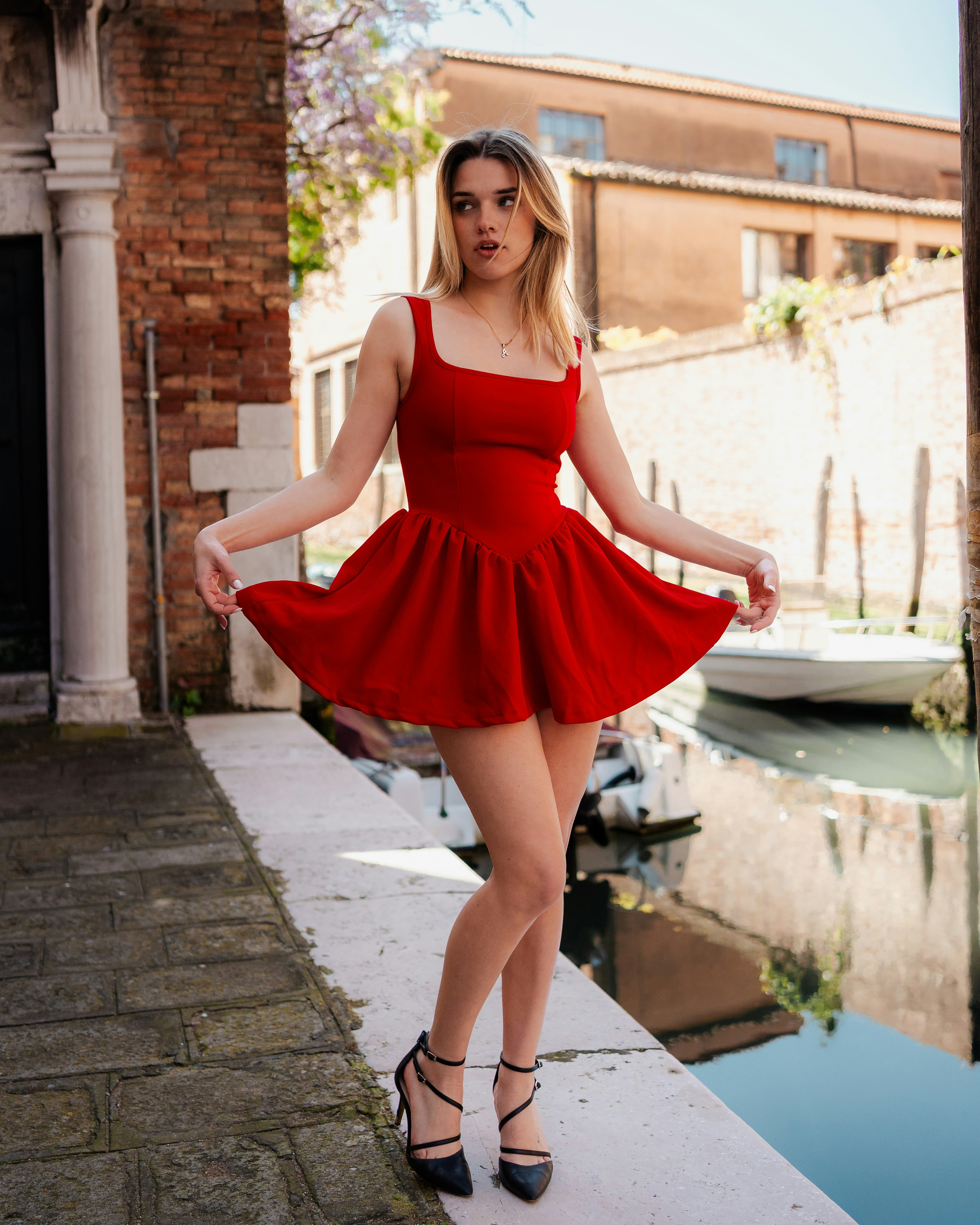 Red Dress at the Canal: A Portrait by the Venetian Wall