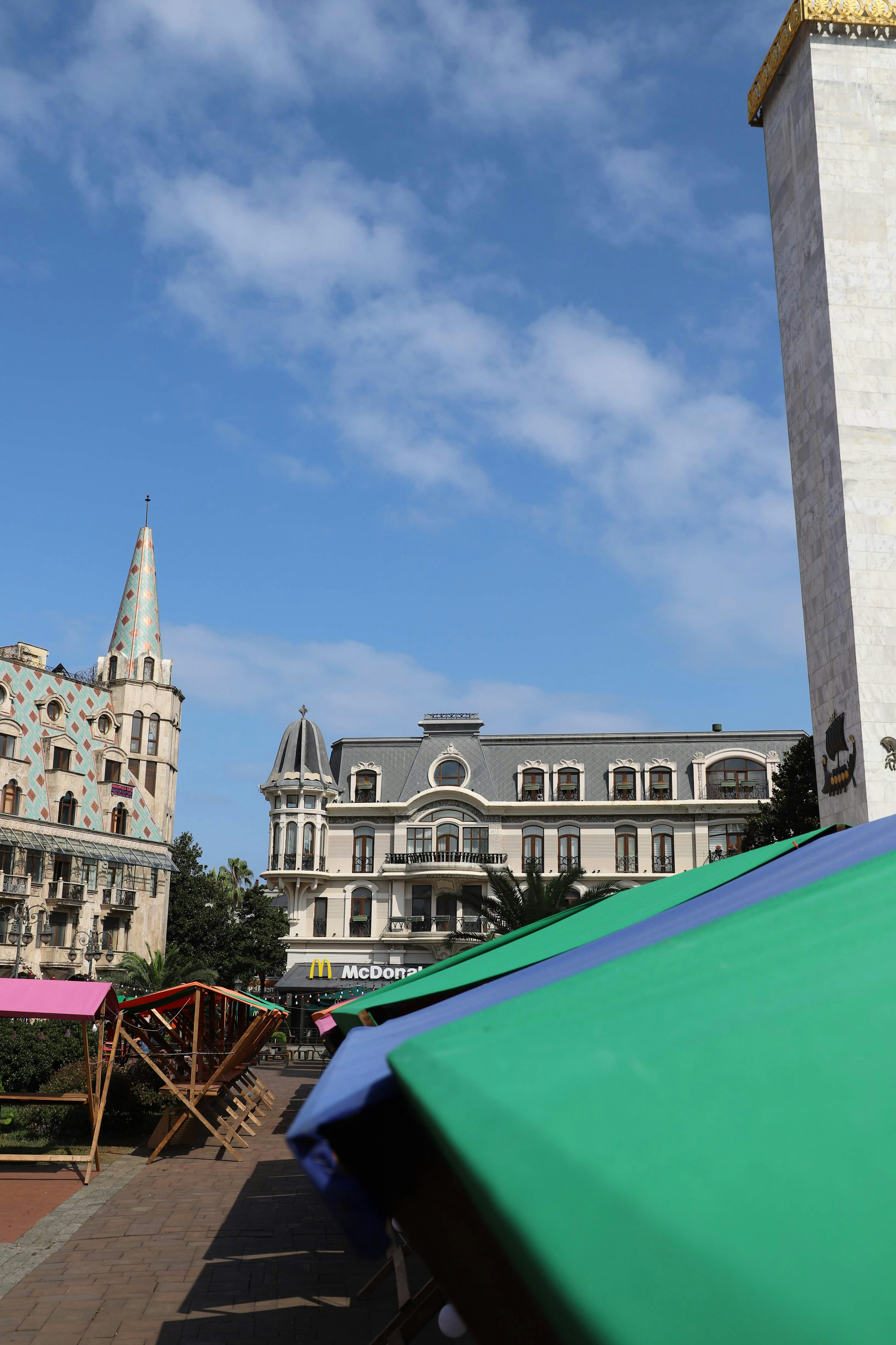 Urban Square Under Colorful Awnings and Historic Rooftops