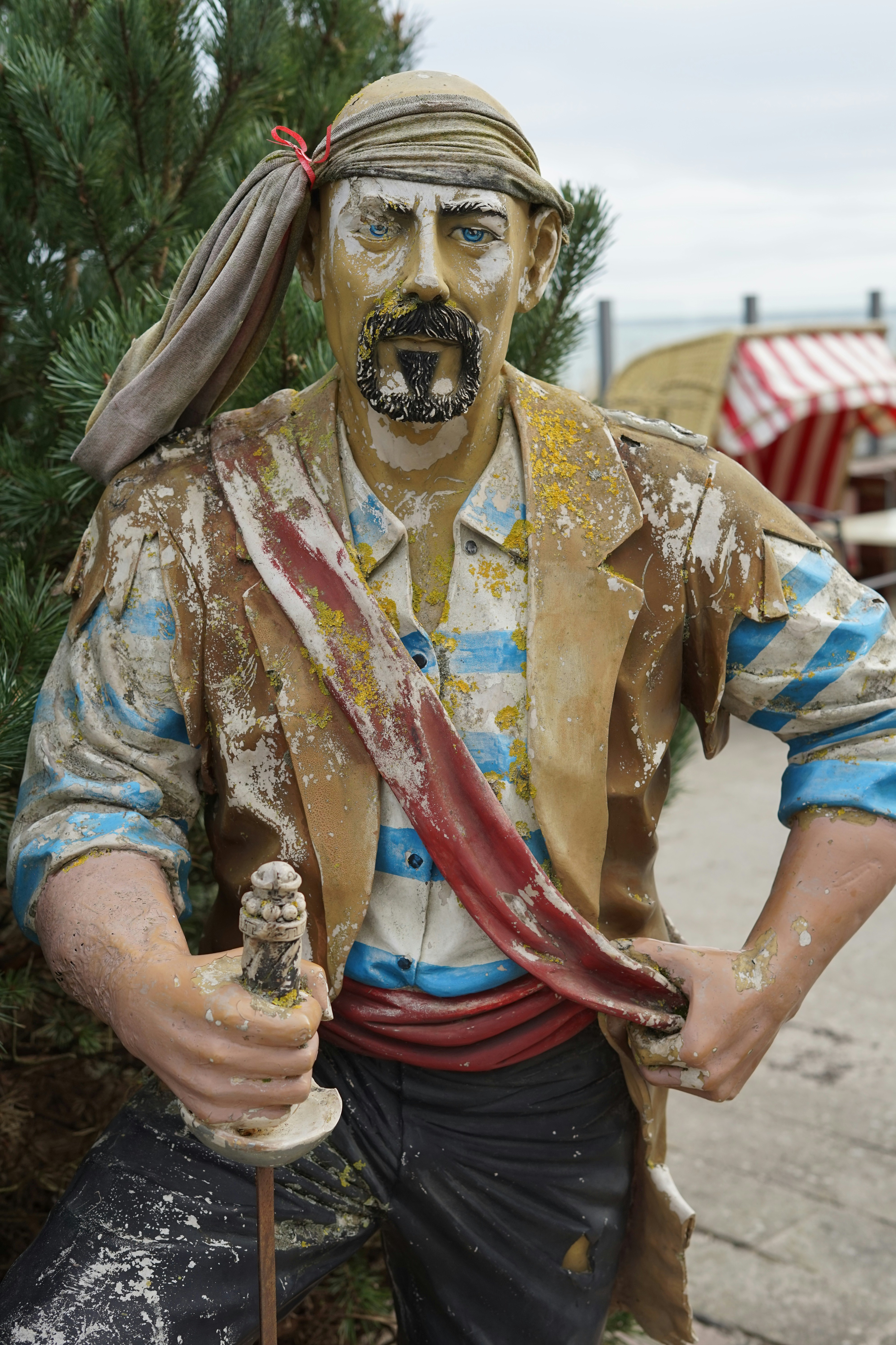 Mud-Splattered Buccaneer Statue Warding Off the Shoreline?
