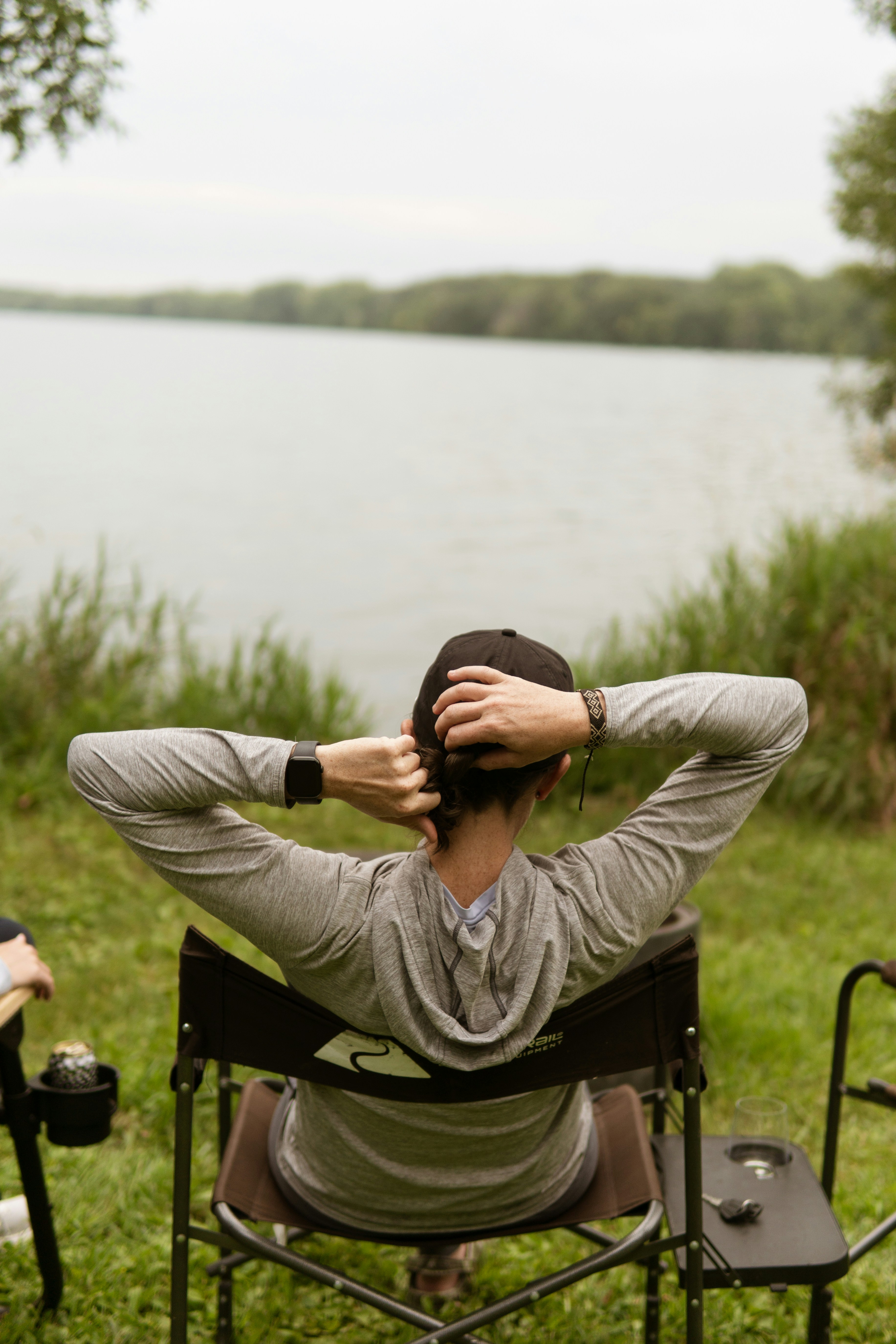 Relaxed Riverside Reflection: A Man Seated by the Lake