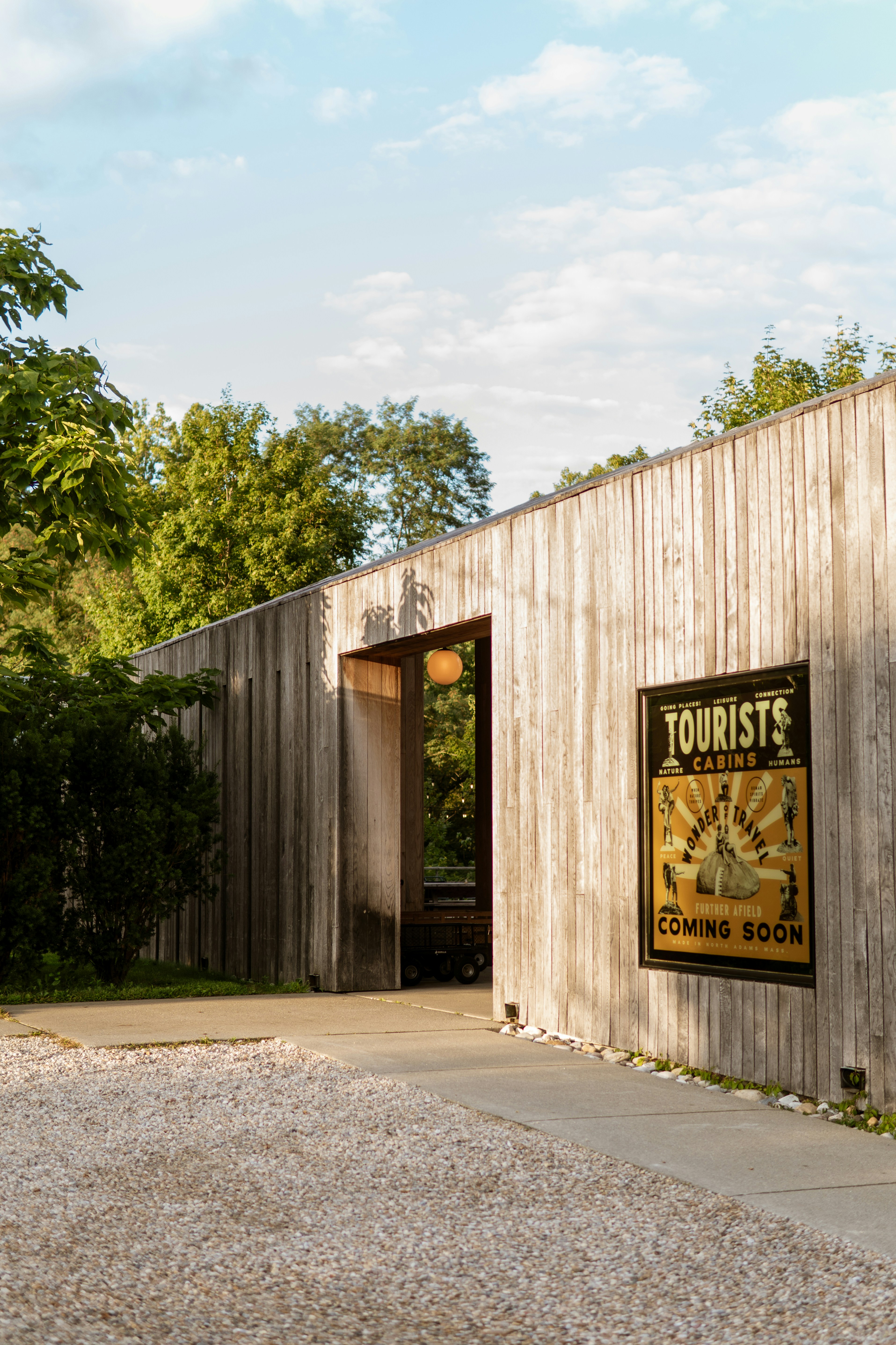 Weathered Wooden Archway Framed by Greenery and a Vintage Poster