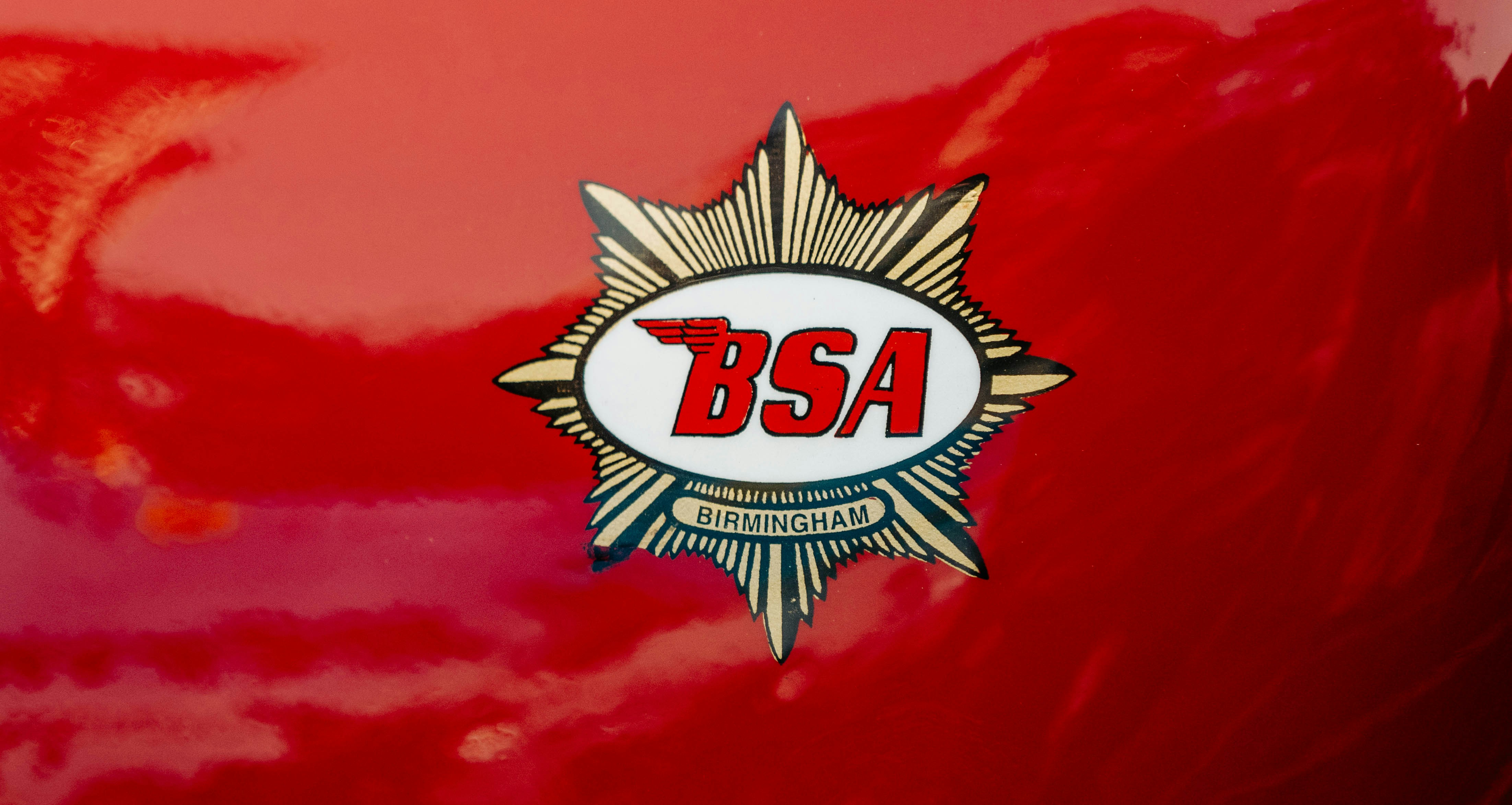 Red background with a gold and white bsa logo.