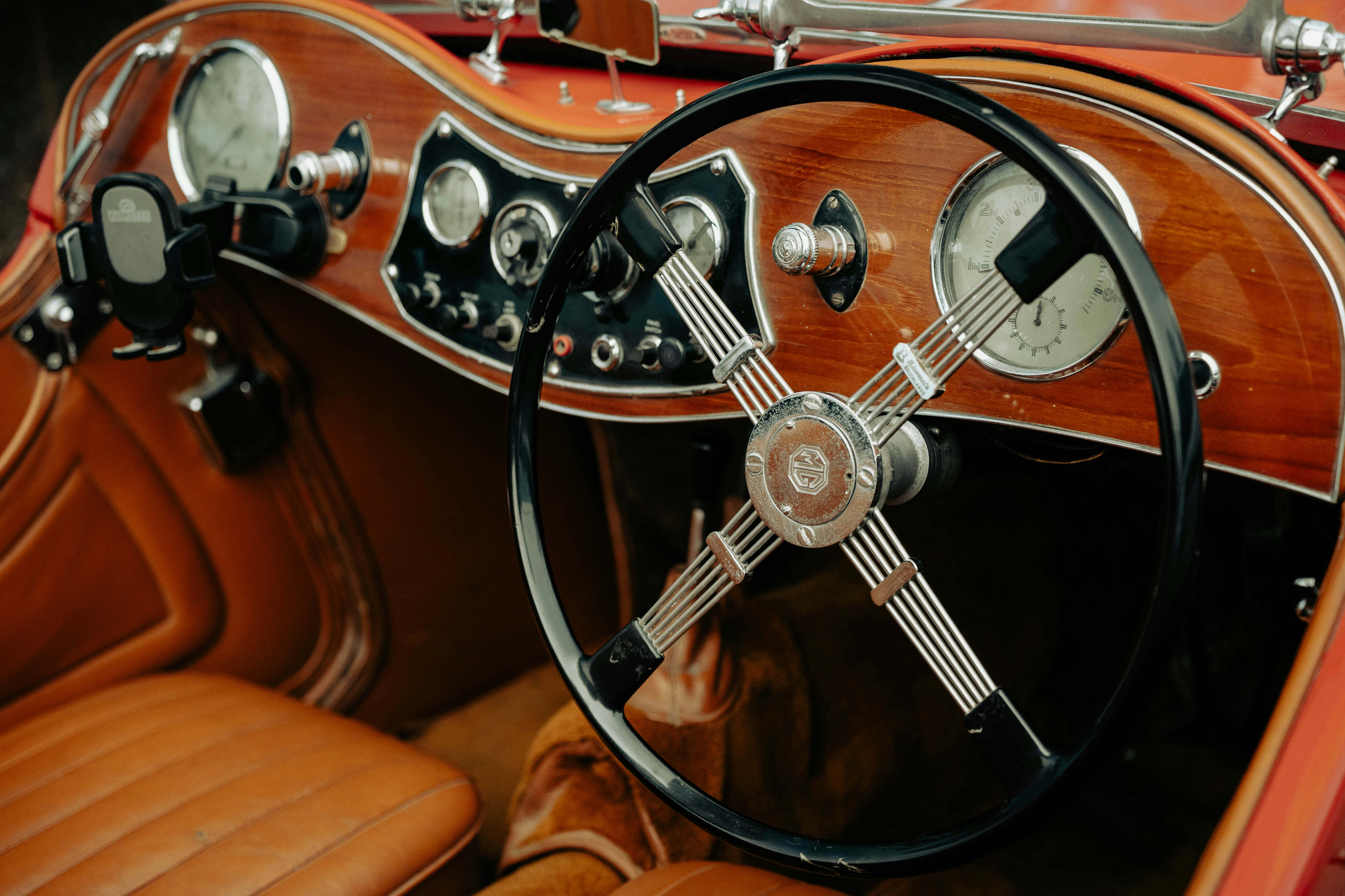 Vintage car dashboard with wooden trim and leather seats