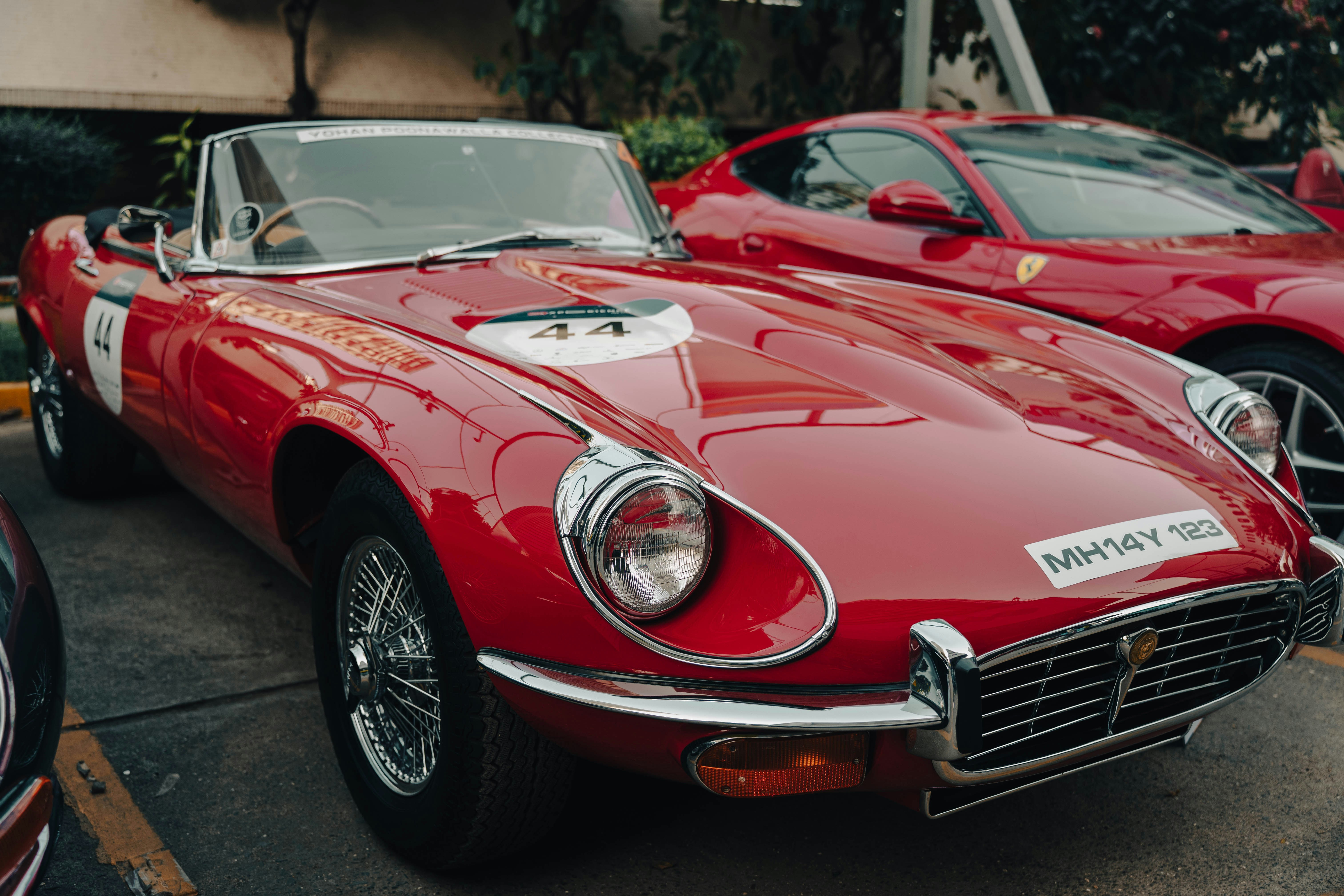 A red classic convertible car parked outdoors.
