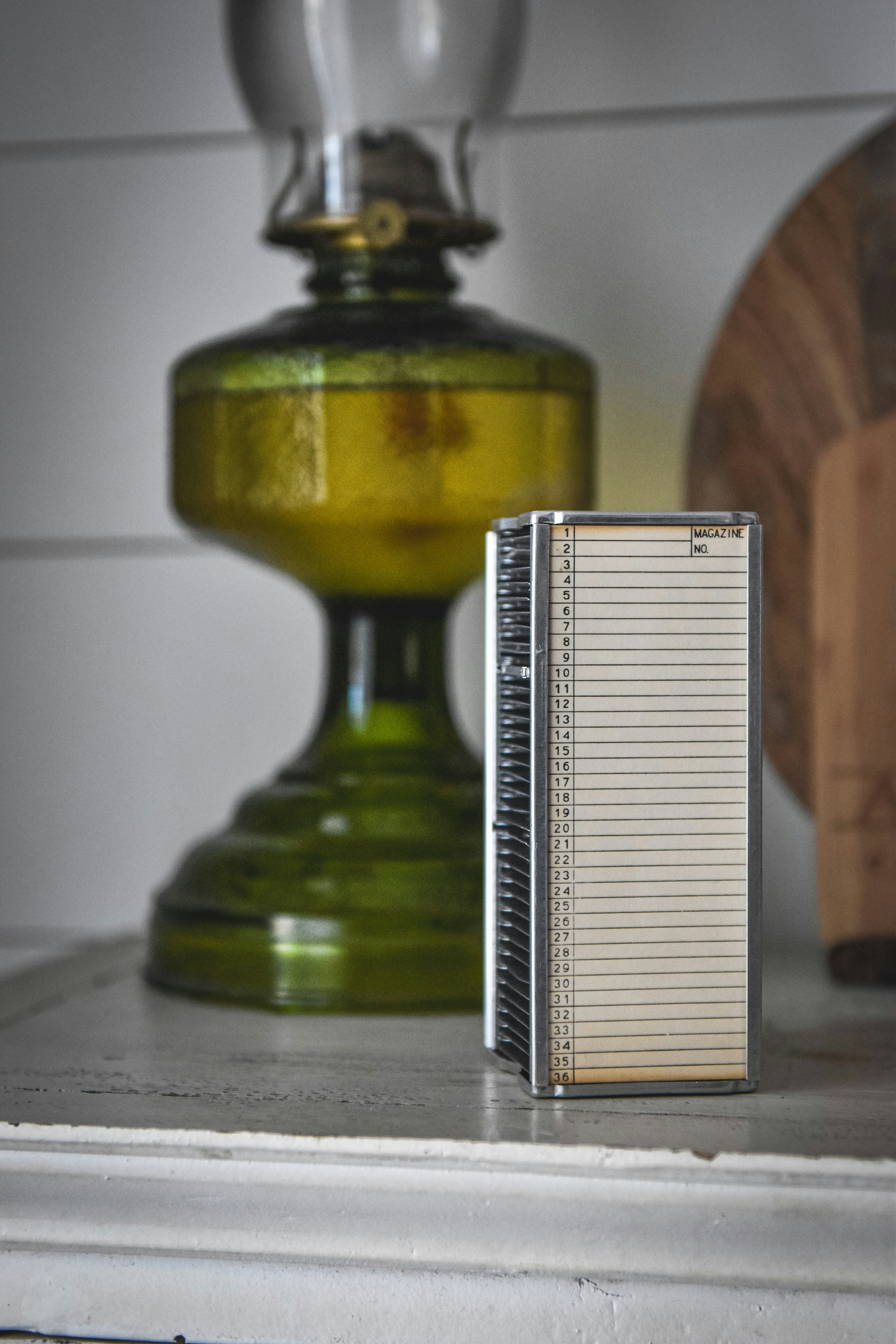 Tiny Matchbox Magnet: A Miniature View of a Vintage Game-Book in Front of a Green Lamp
