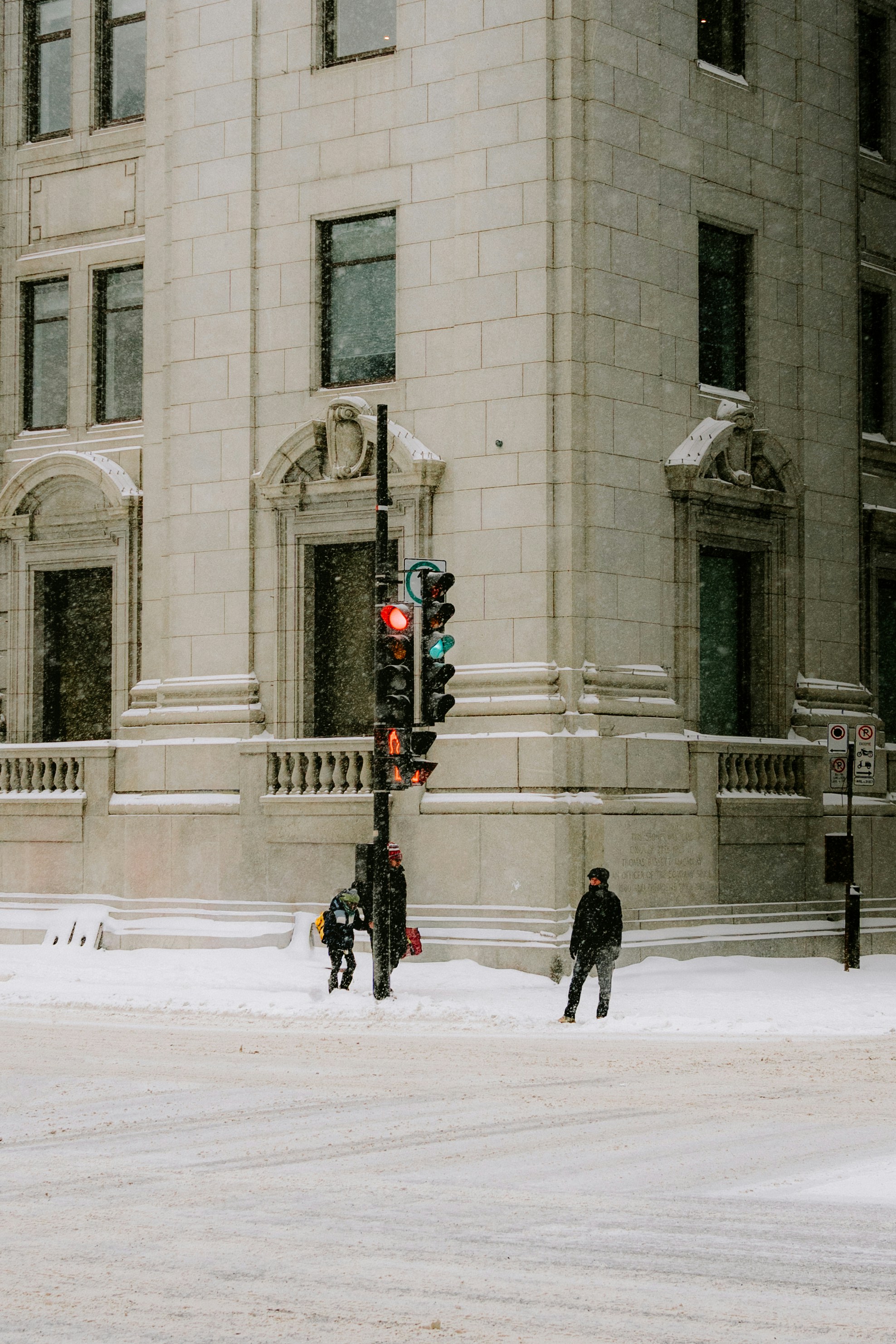 Red Light Through Snow: Street Scene at a Monumental Facade