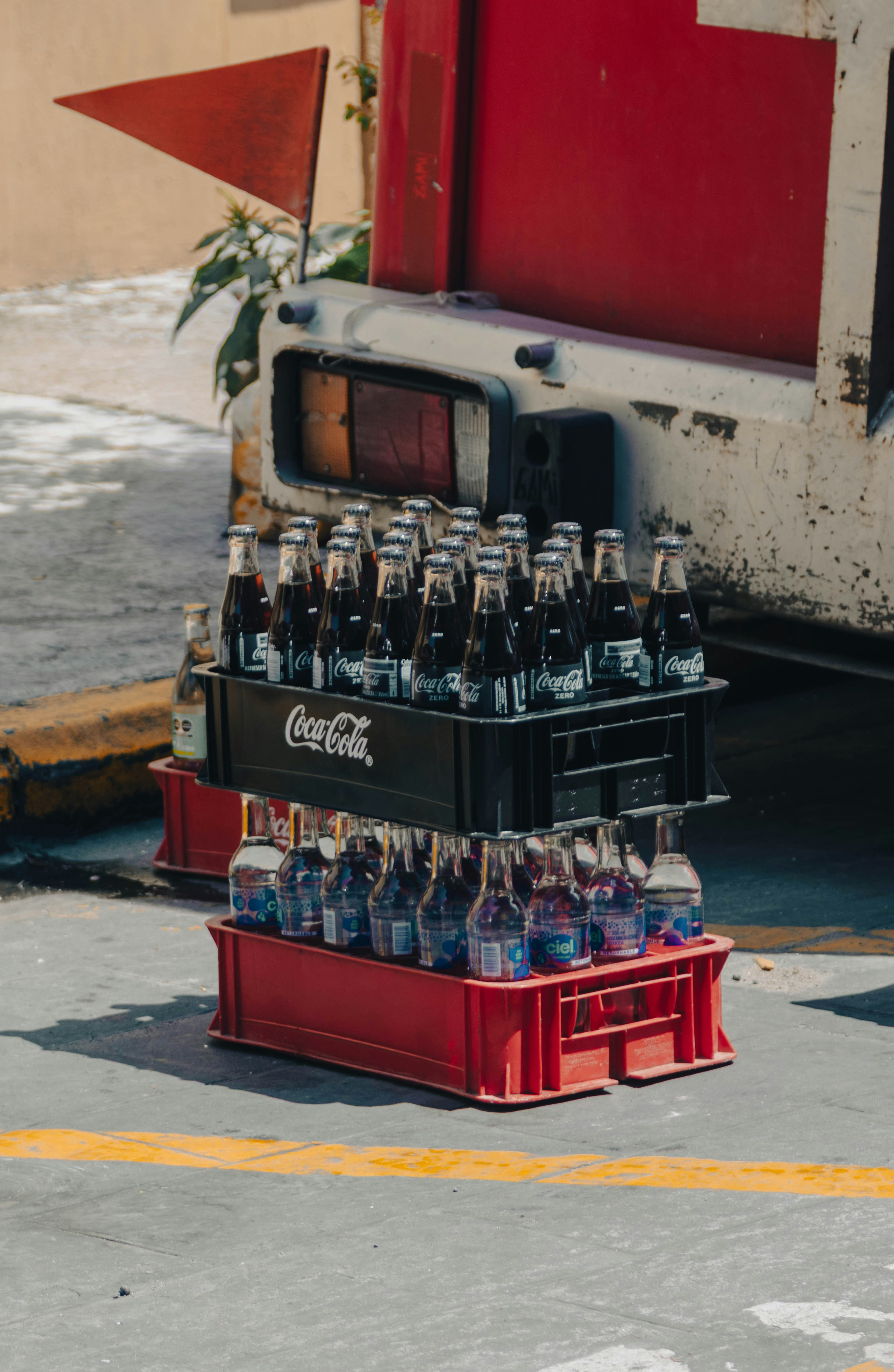 Stacked Coca-Cola Crates at a Distant Stoplight