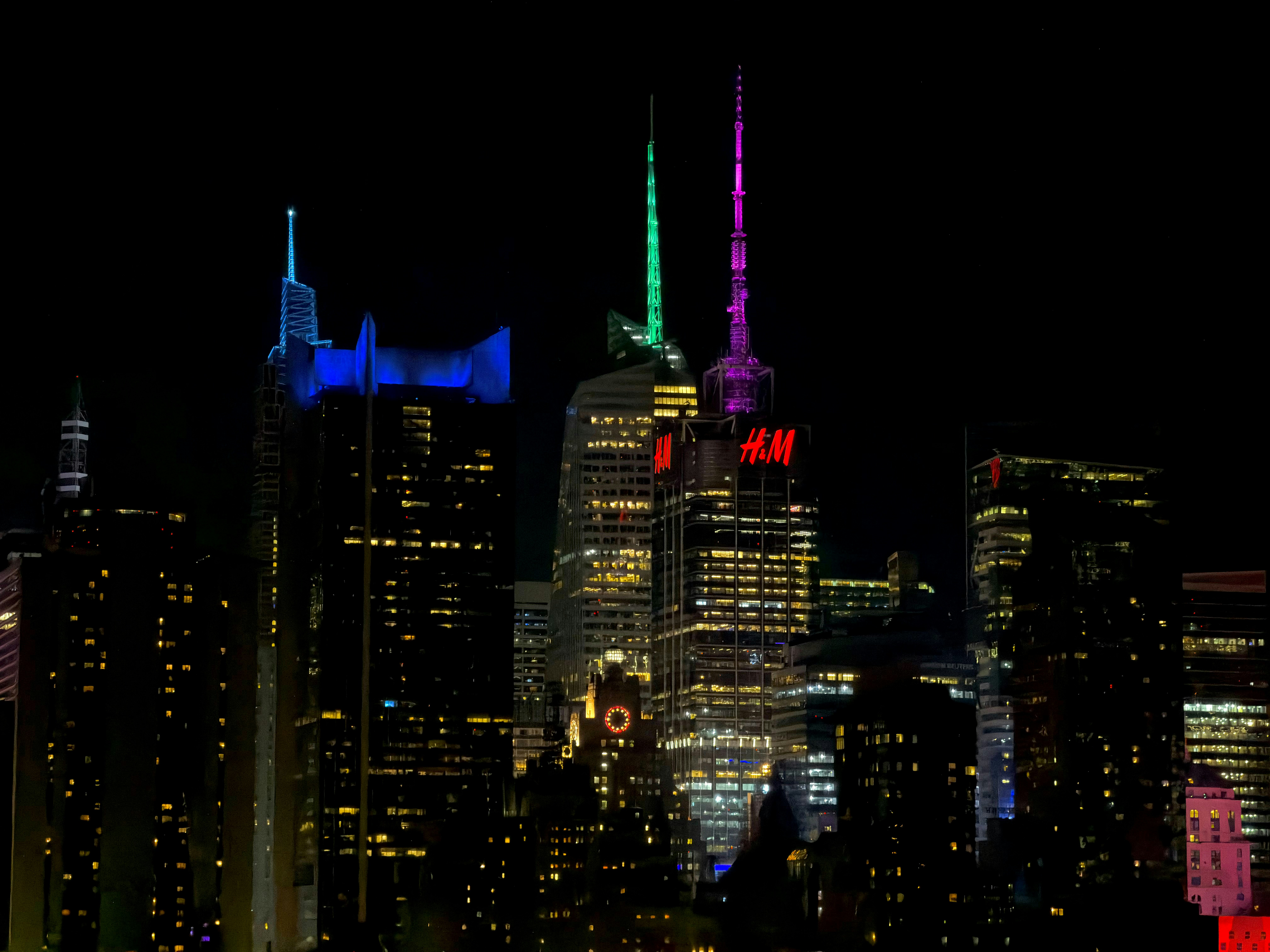 Neon Skyline: Towers of Color Against a Velvet Night