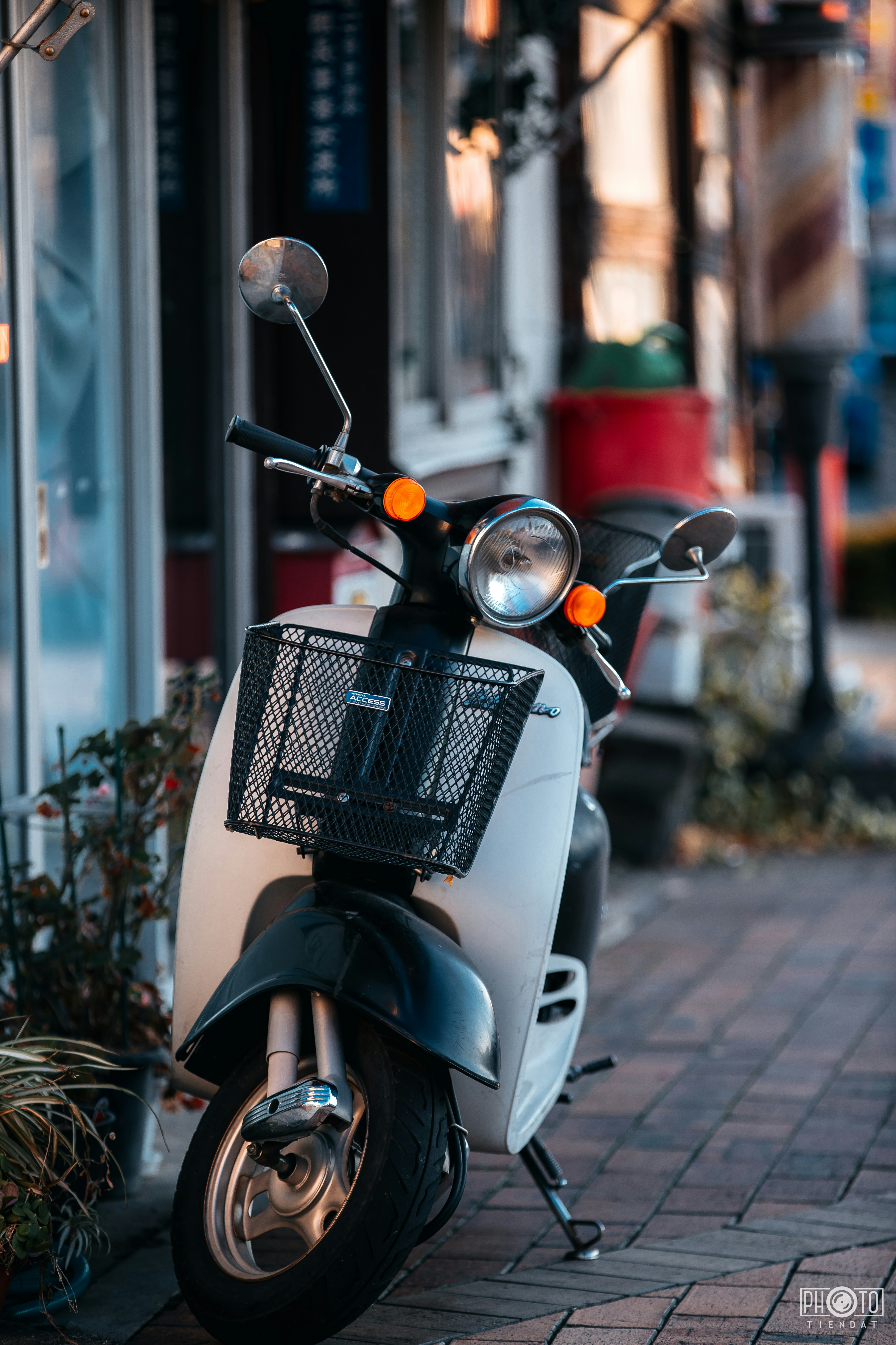 Scooter in a Quiet Street: Neon Reflections on Chrome and Basket
