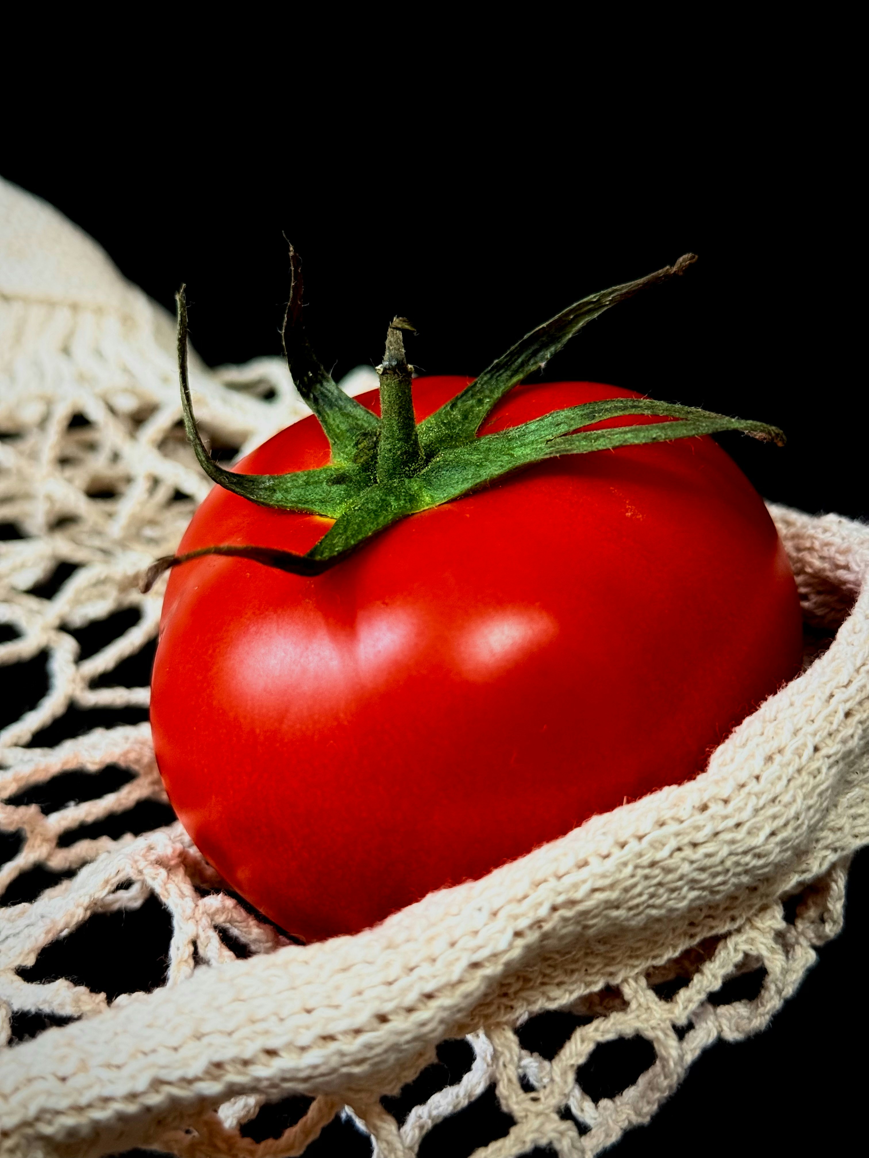 Crimson Tomato Nestled in Crochet Lace