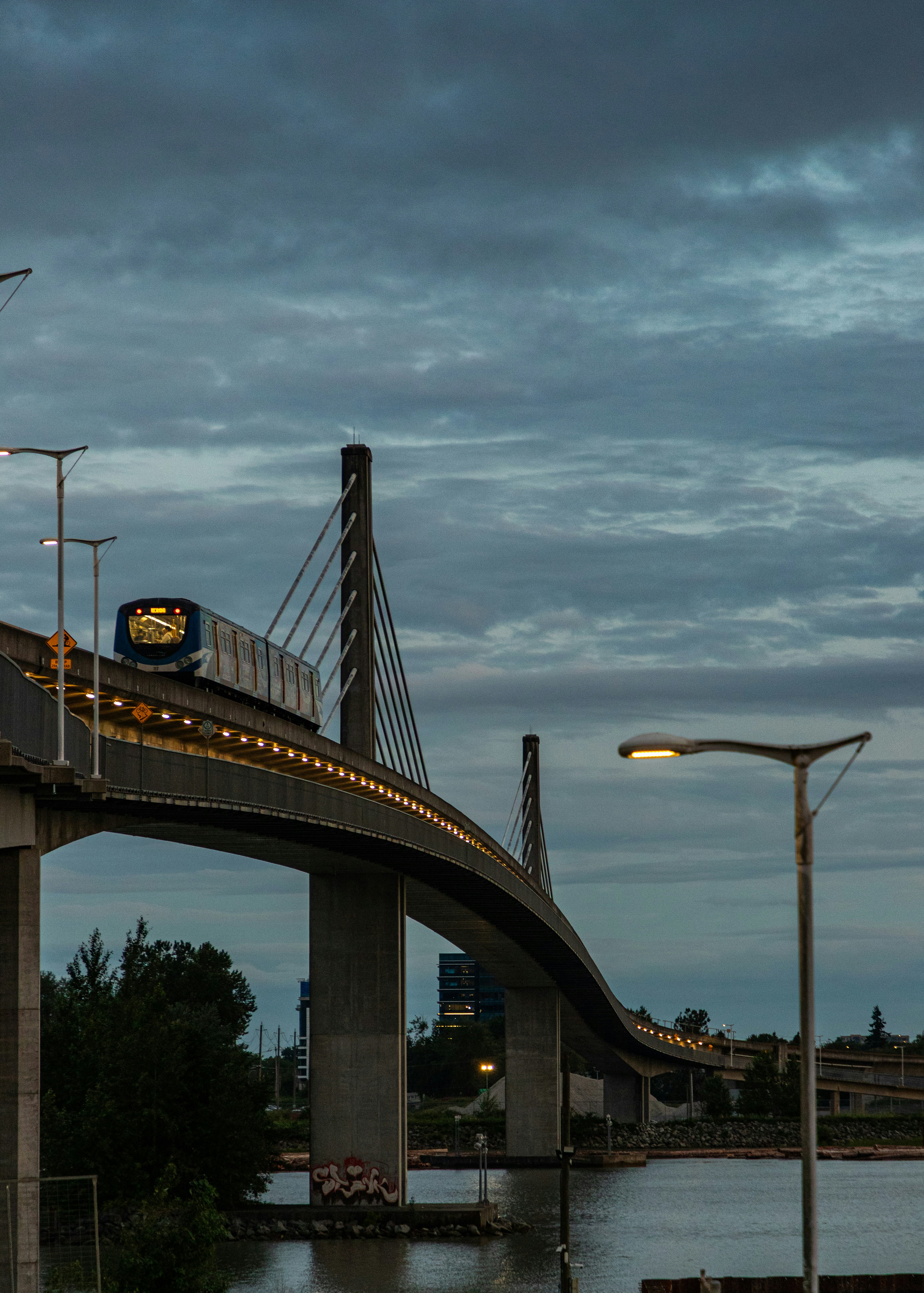 Bridge Commuter: A Train Traverses the Evening Span