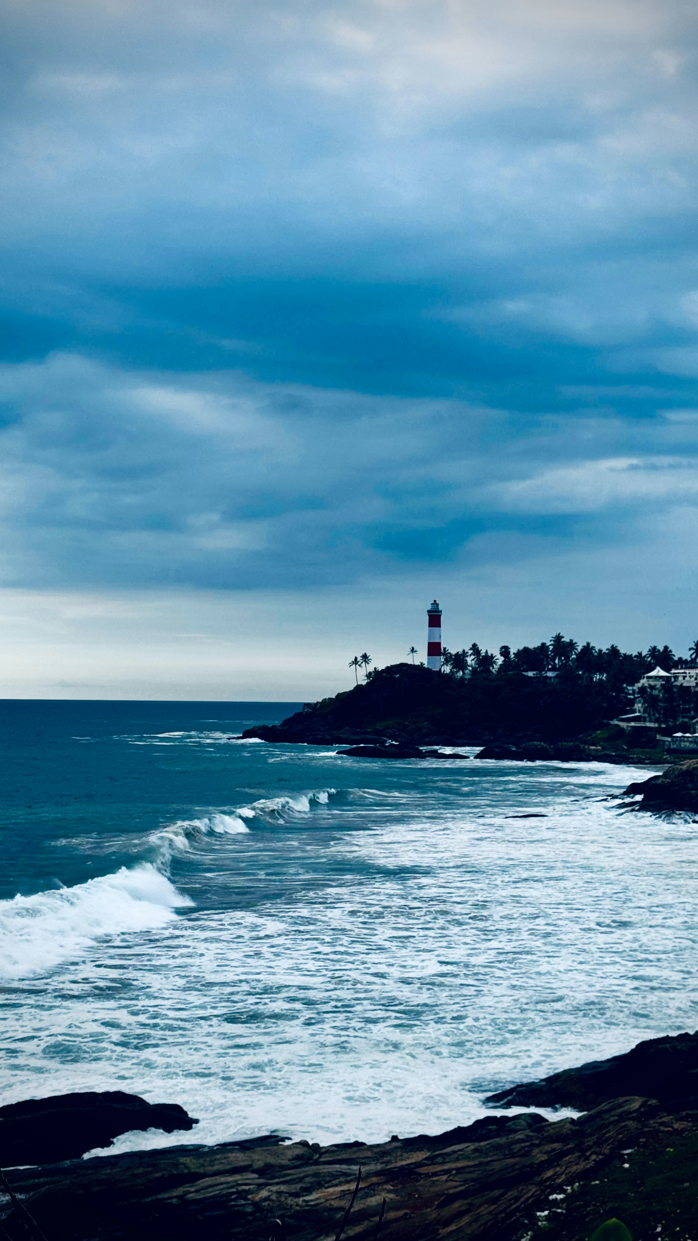 Lighthouse Point: Waves Meet the Cliff at Dusk