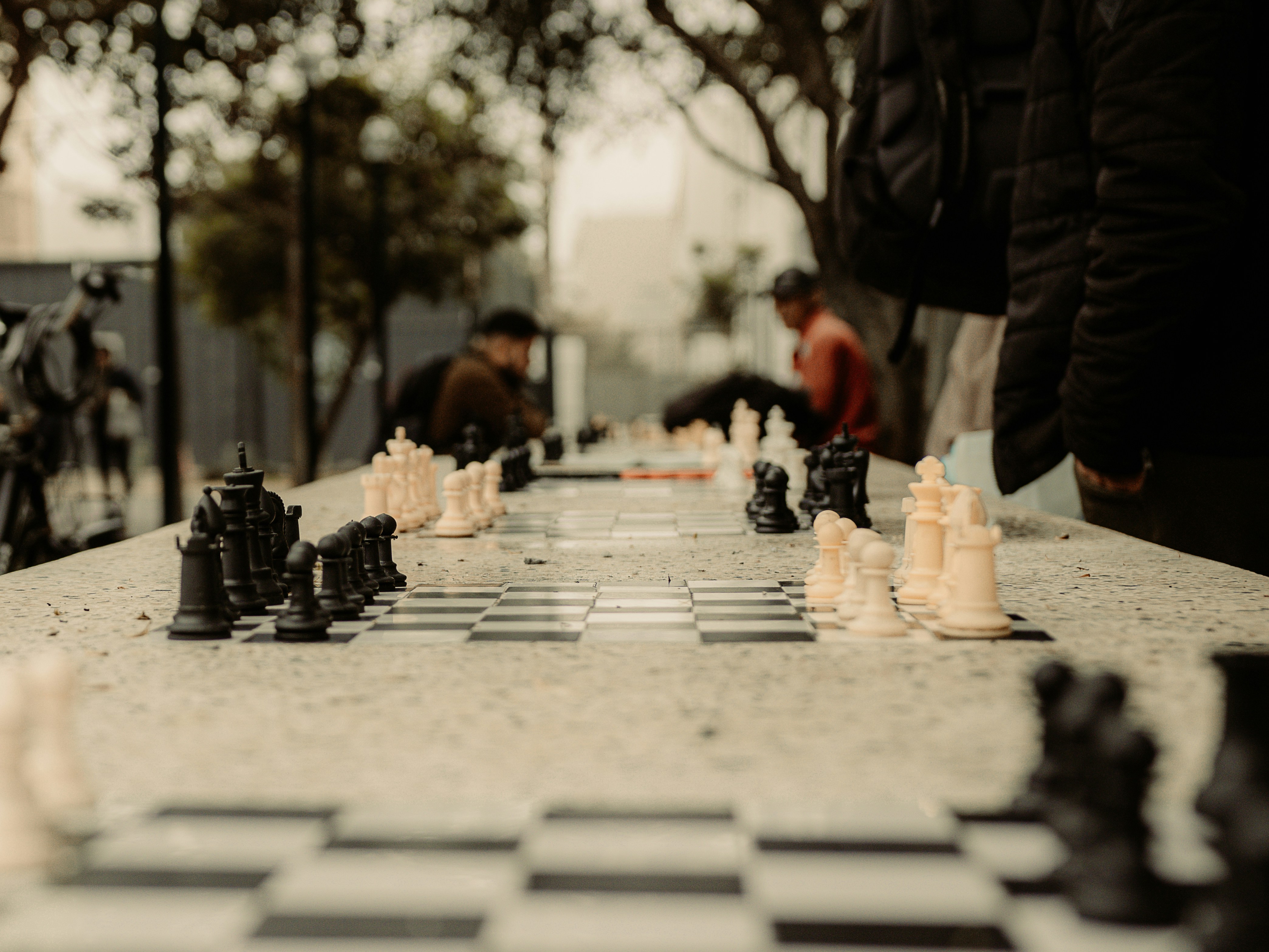 Urban Chessboard: A Quiet Moment Amid the City Flux
